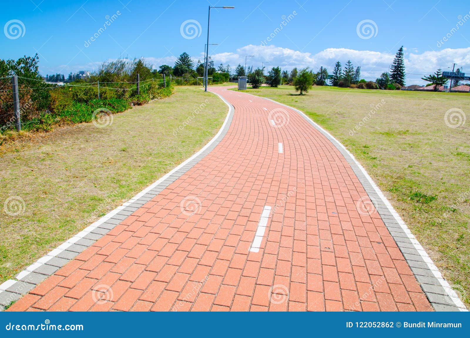 Red Brick Cycle Path and Footpath in the Park with Green Field. Stock ...