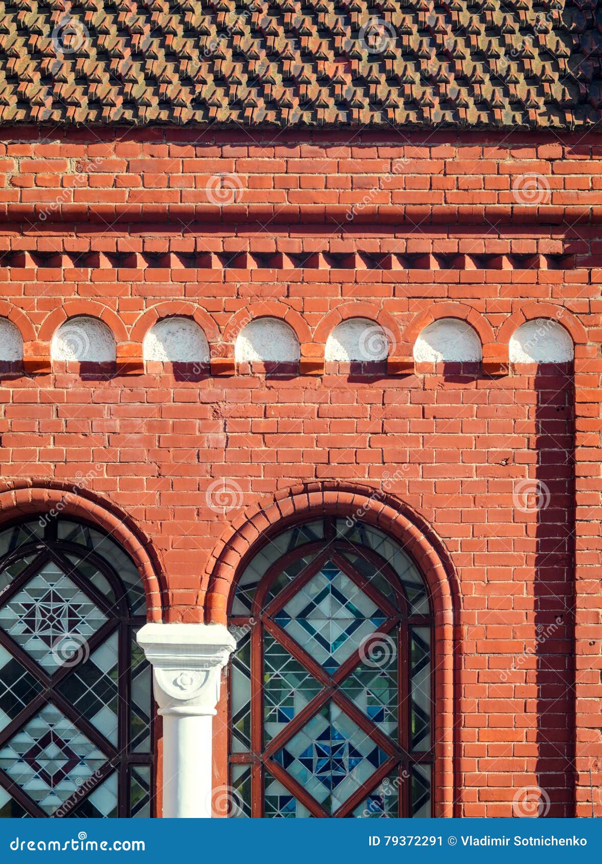Red Brick Facade with Arched Stained Windows Stock Image - Image of ...