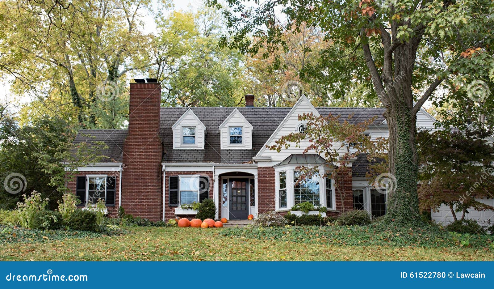 Red Brick House in Wooded Setting with Pumpkins Stock Photo - Image of ...