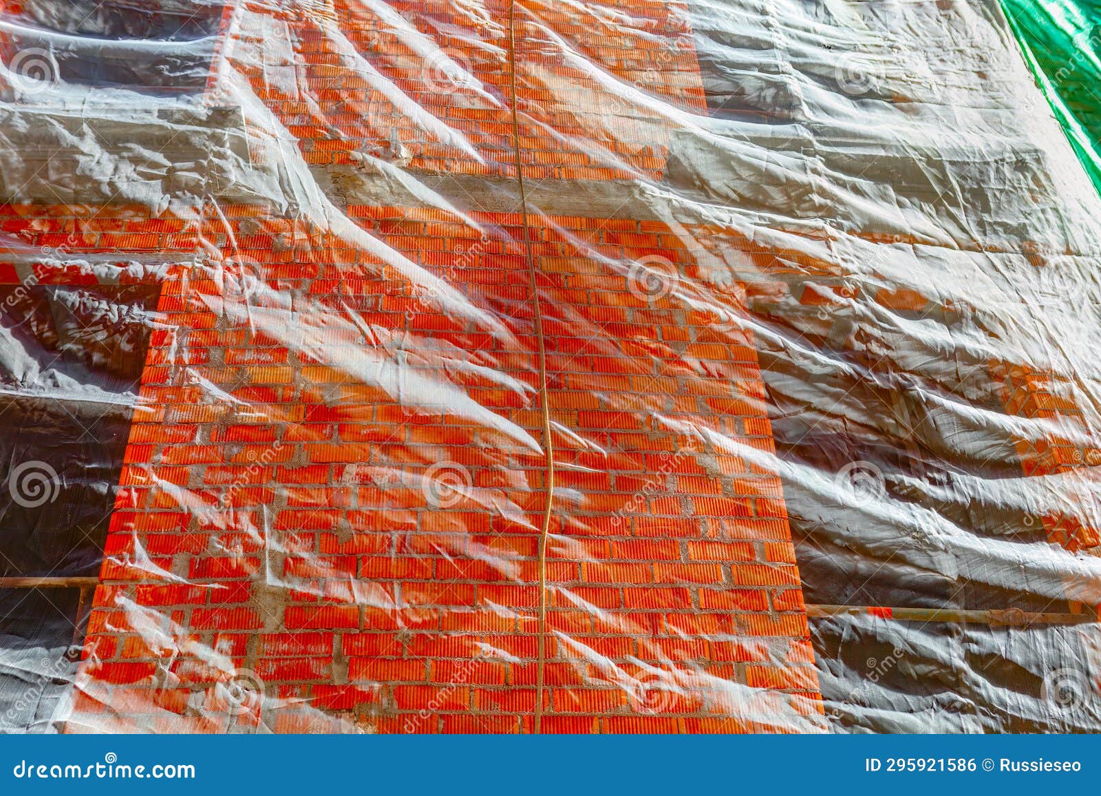 Red Brick Wall Under Construction Stock Photo - Image of covered, mesh ...