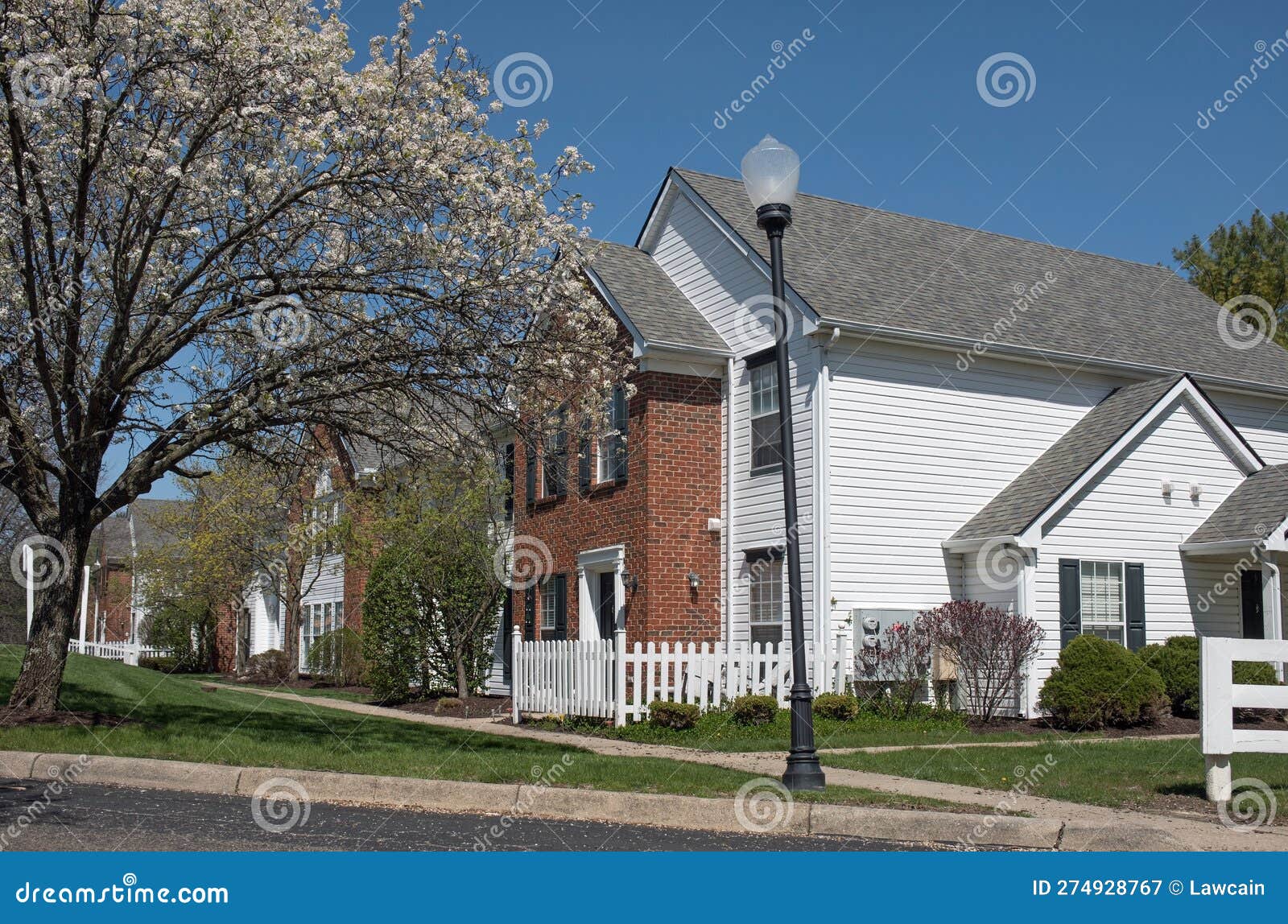 Red Brick and White Apartment Complex in Springtime Stock Image - Image ...