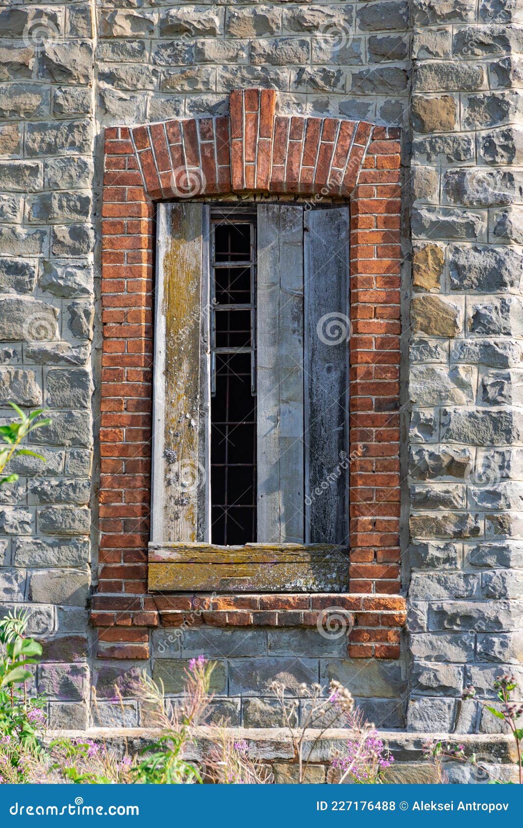 Red Brick Window Of An Ancient Castle In A Wall Of Natural Gray Stone ...