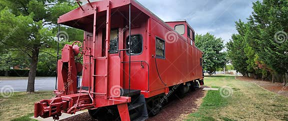A Red Caboose in a Park Surrounded by Trees Stock Image - Image of ...