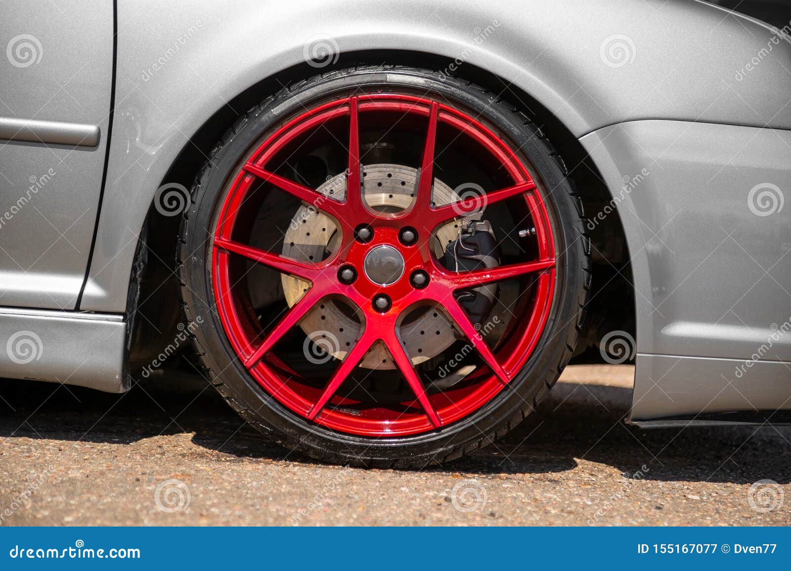 Red Candy Colored Light Alloy Wheels on Silver Hatchback Stock Image ...