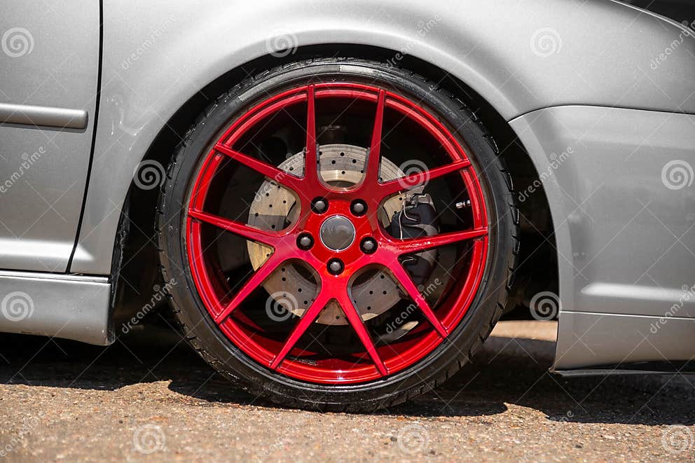 Red Candy Colored Light Alloy Wheels on Silver Hatchback Stock Image ...