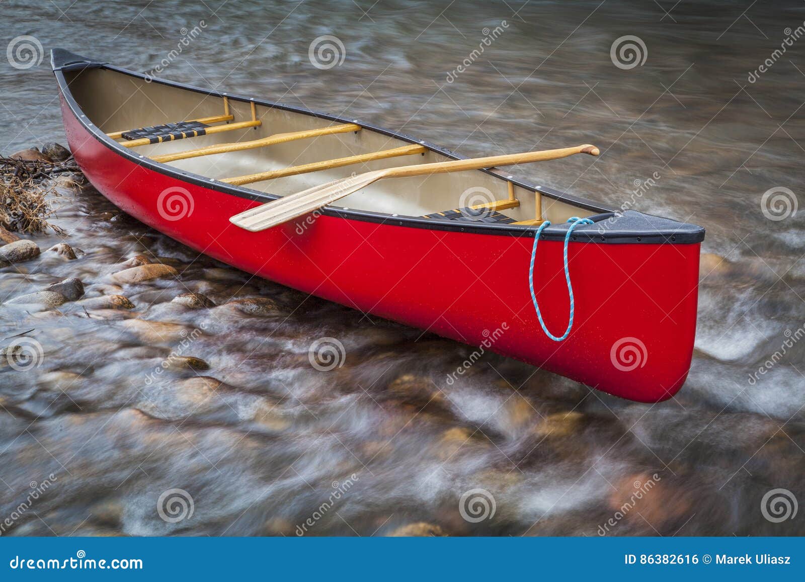 Red Canoe on a Shallow Rocky River Stock Photo - Image of rock, stern ...