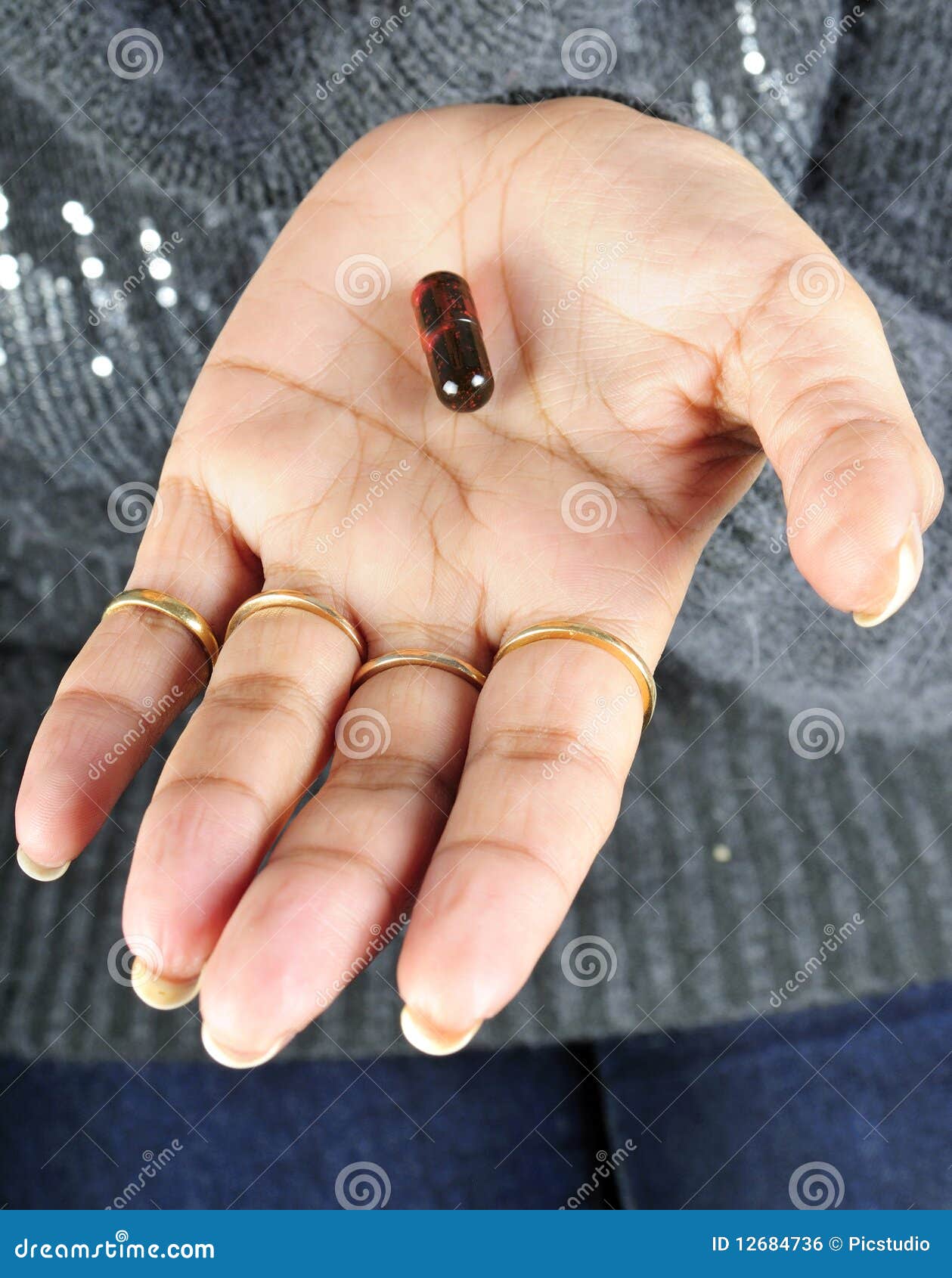 Red capsule stock photo. Image of hand, gold, female - 12684736