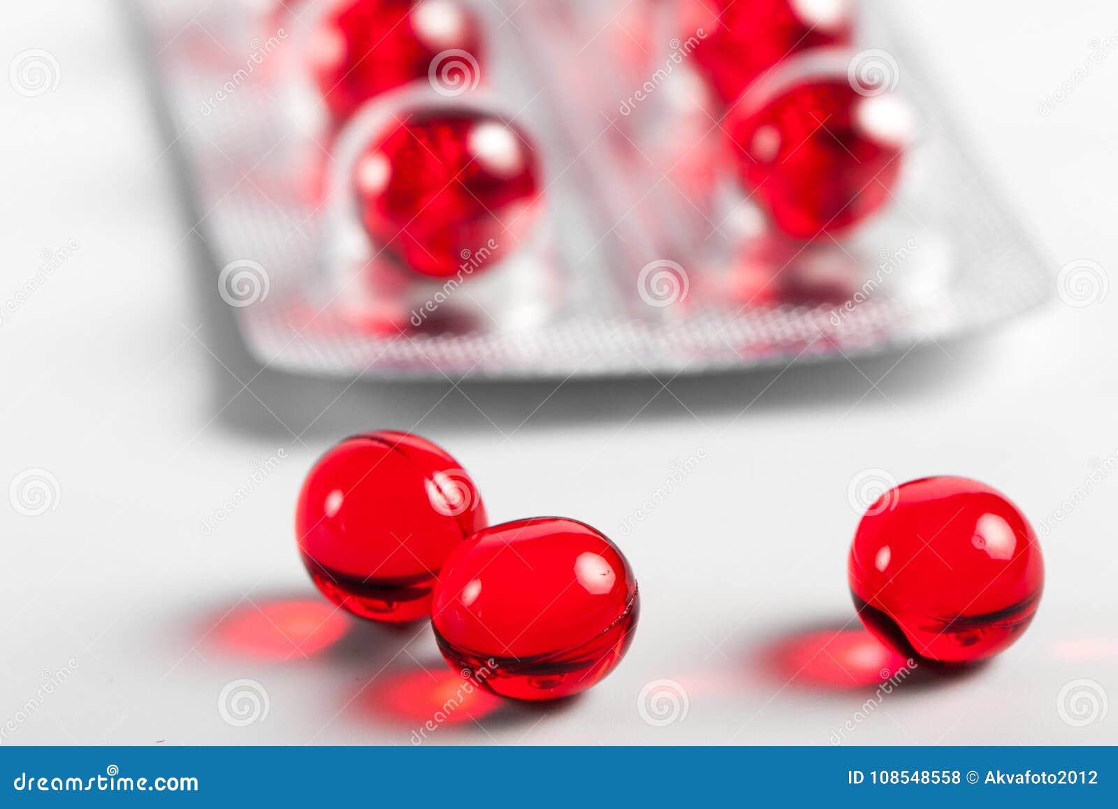 Red Capsules Closeup on a White Background. Medical Background. Macro ...