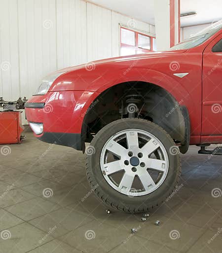Red car lifted on raiser stock photo. Image of garage - 13111372
