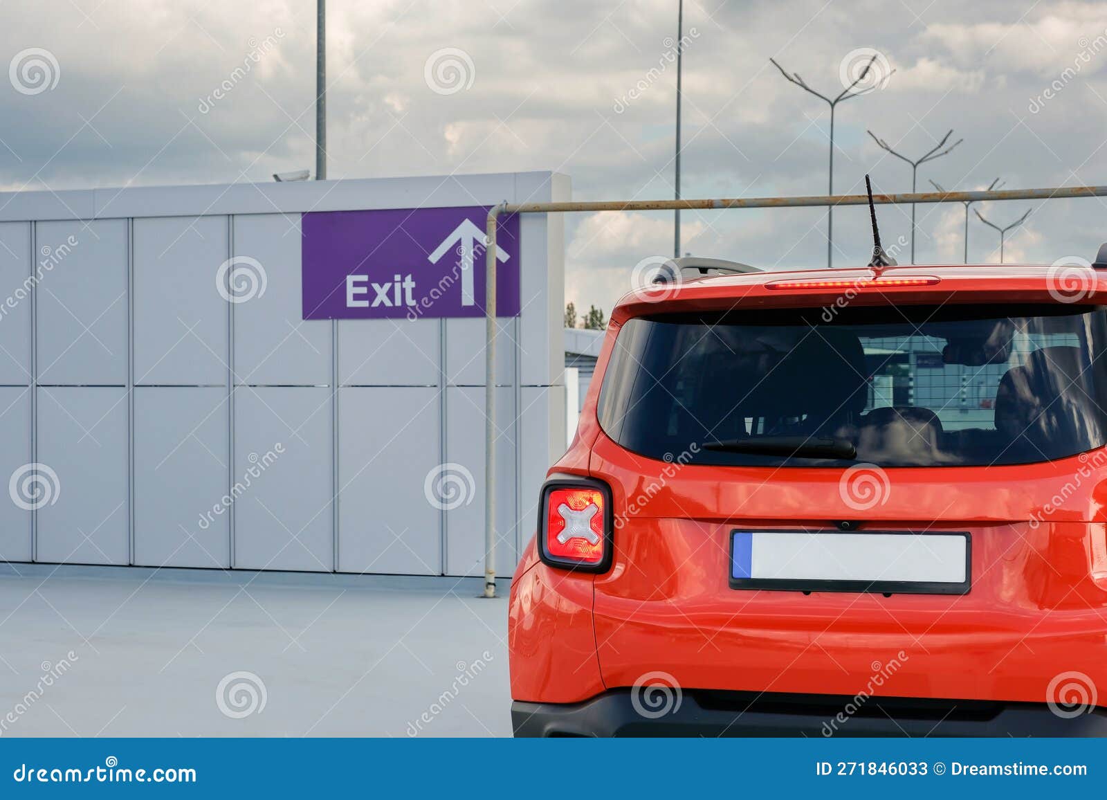 A Red Car Stands in Front of the Exit of the Parking Lot Stock Image ...