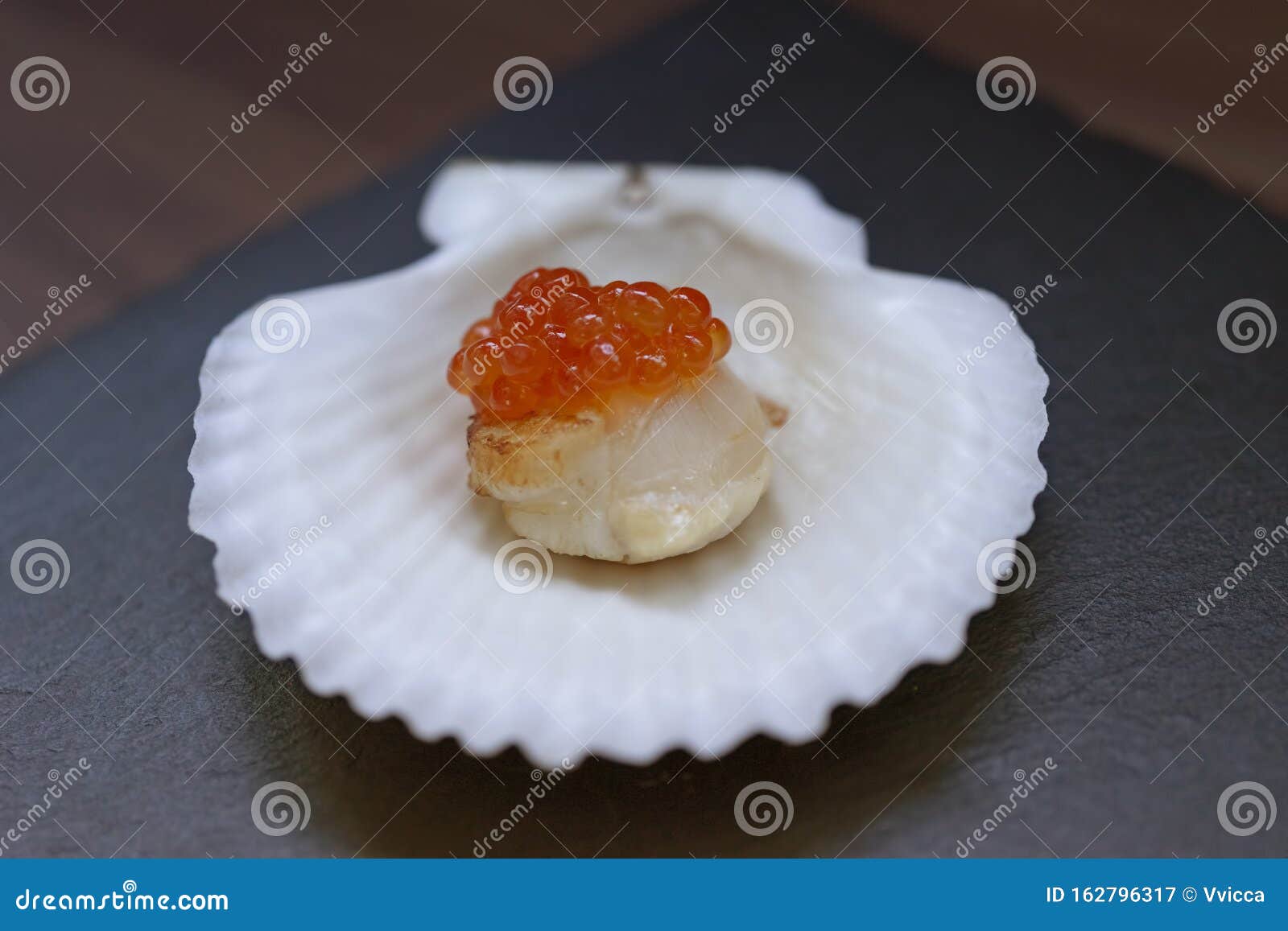 Red Caviar on a Scallop Fillet and on a White Shell Stock Image - Image ...