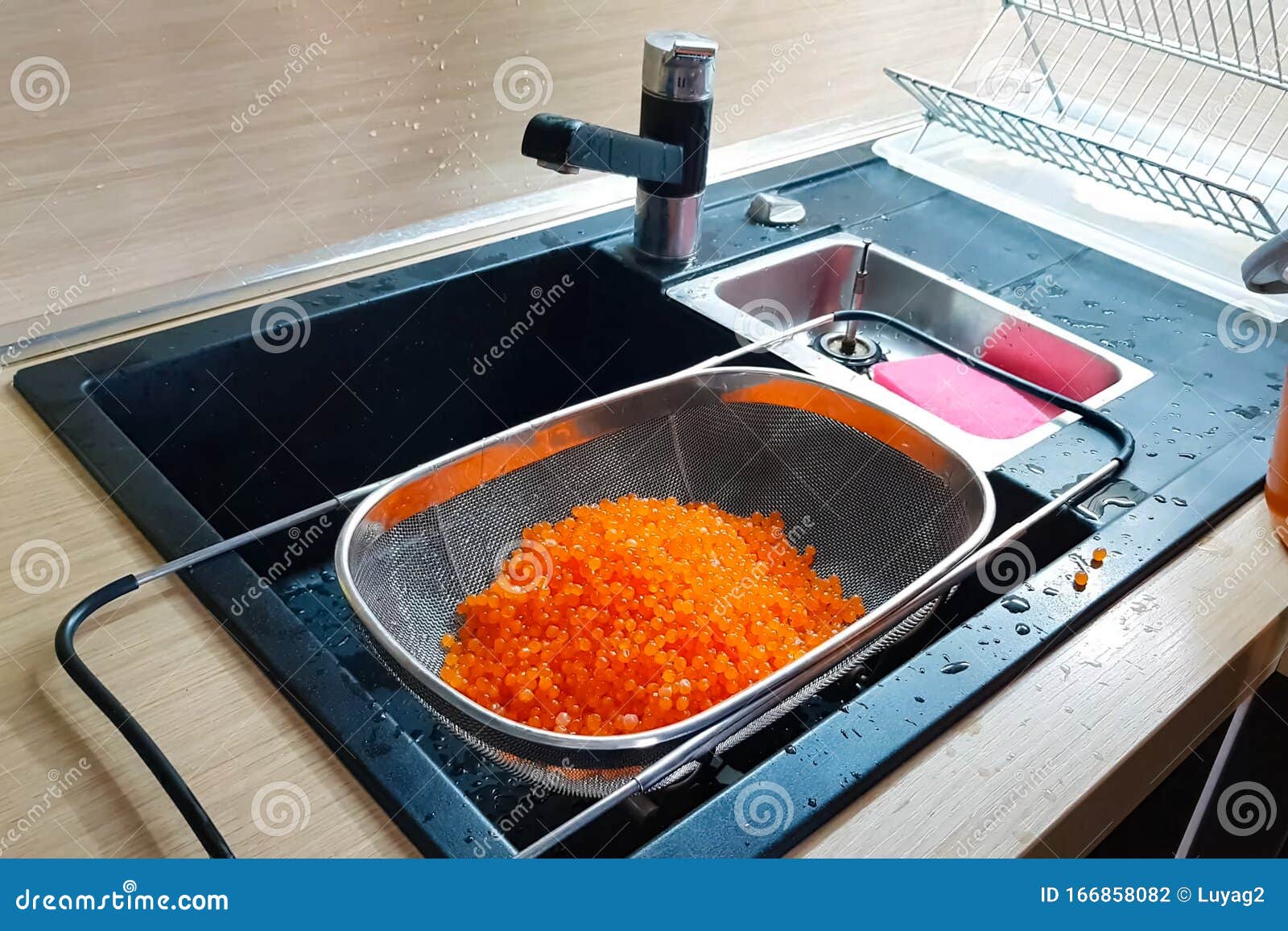 Red Caviar in Sieve for Washing. Flushing Red Caviar Stock Photo ...