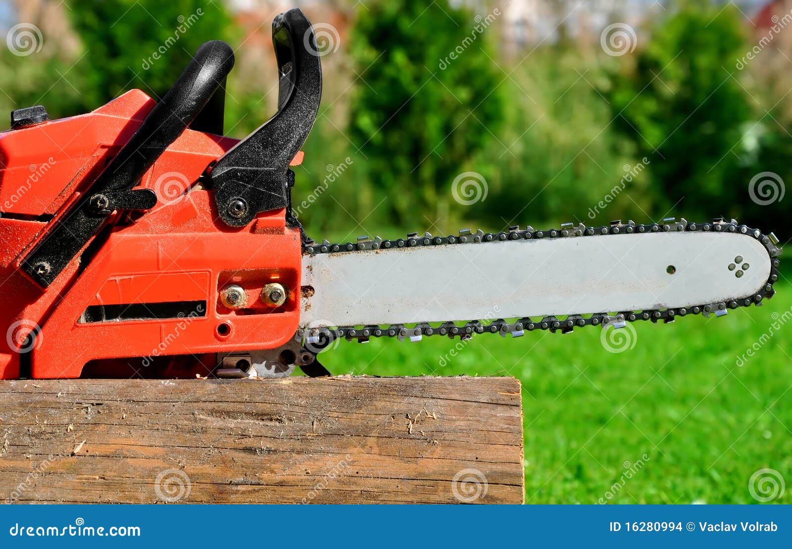 Red chainsaw and wood stock photo. Image of chainsaw - 16280994