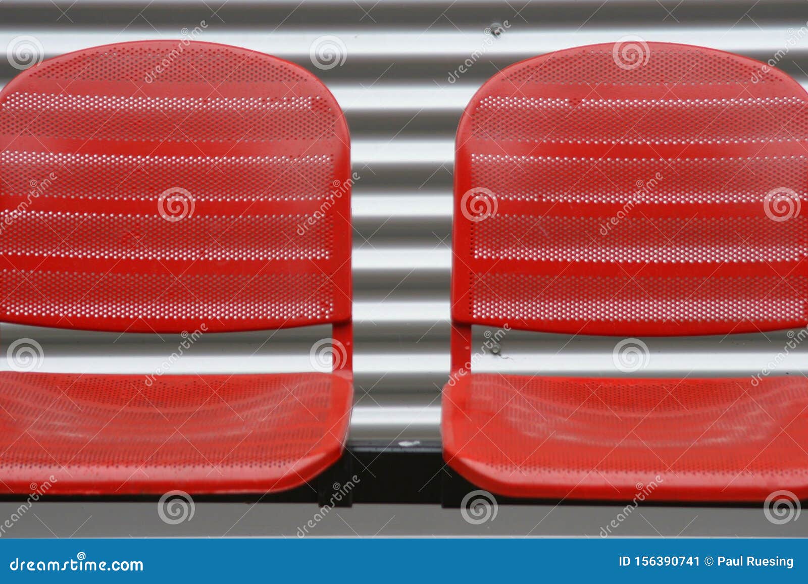 Red Chairs in Front of a Metallic Wall Stock Image - Image of ...