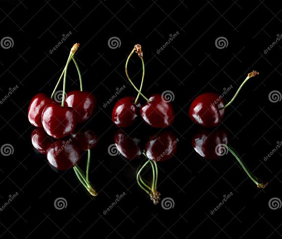 Red Cherries on a Black Background with Reflection. Fresh Cherries on a ...