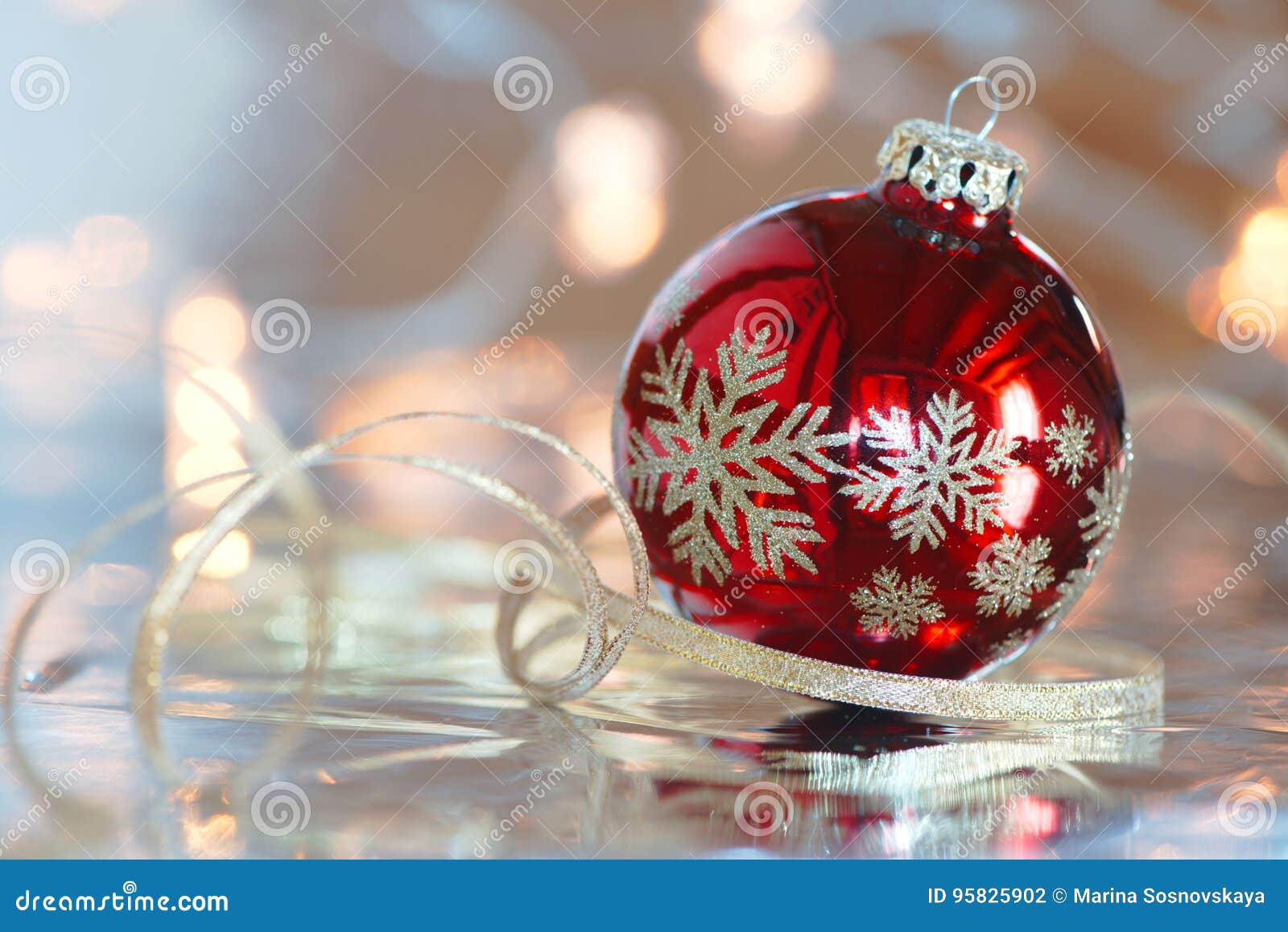 Red Christmas Ball with Reflection Against a Light Blue Background ...