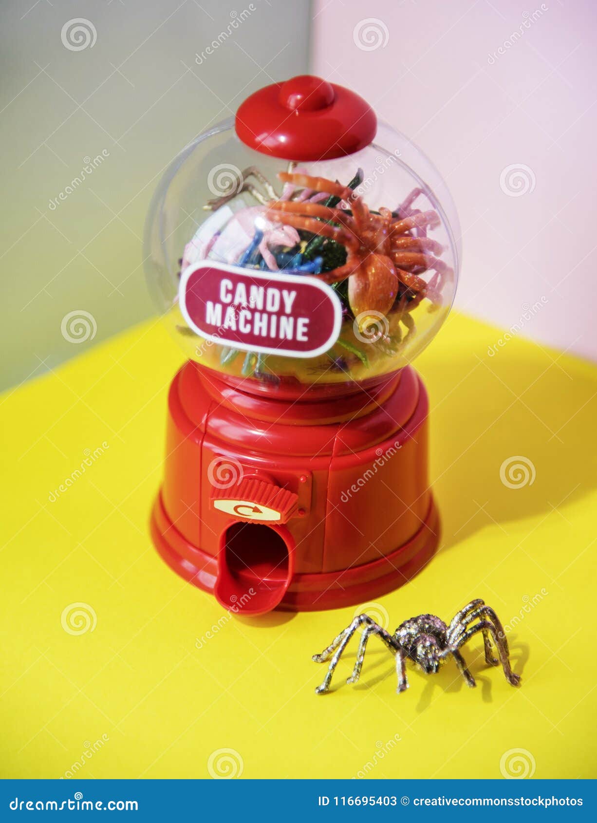 Red And Clear Plastic Candy Machine On Yellow Desk Picture. Image ...