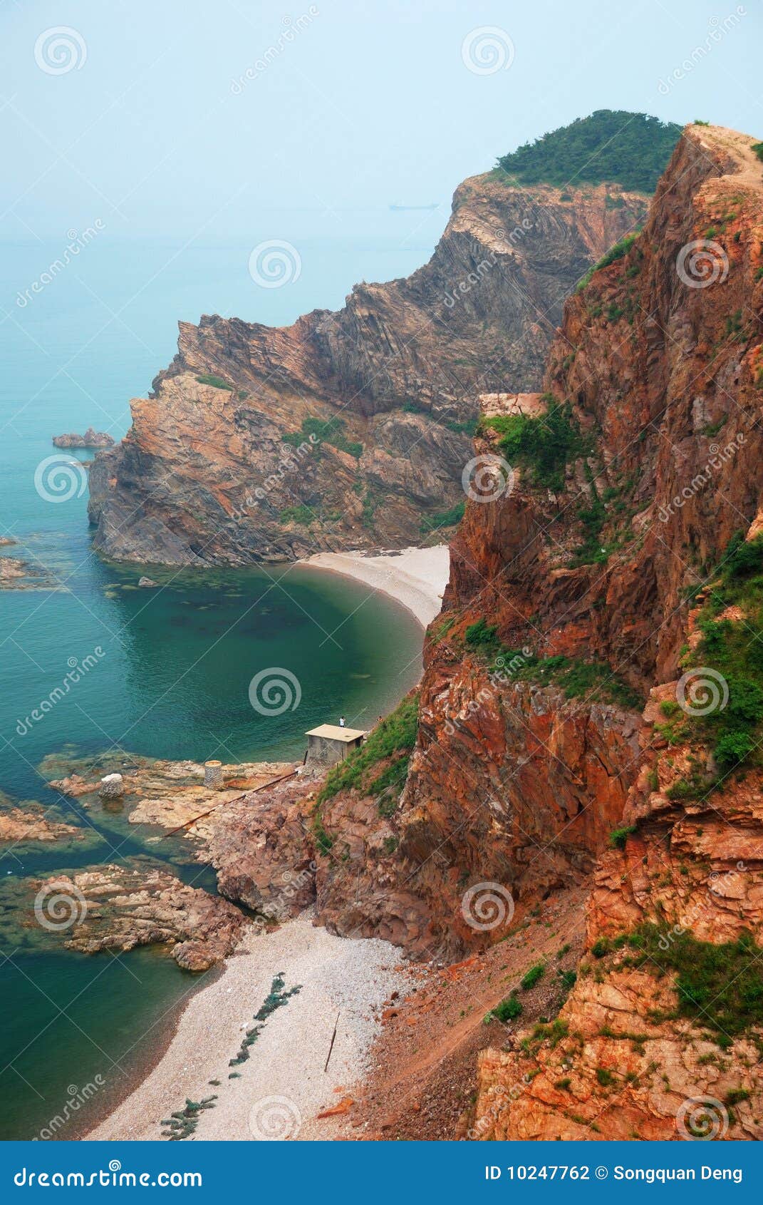 Red cliff at sea shore stock photo. Image of forest, rock - 10247762