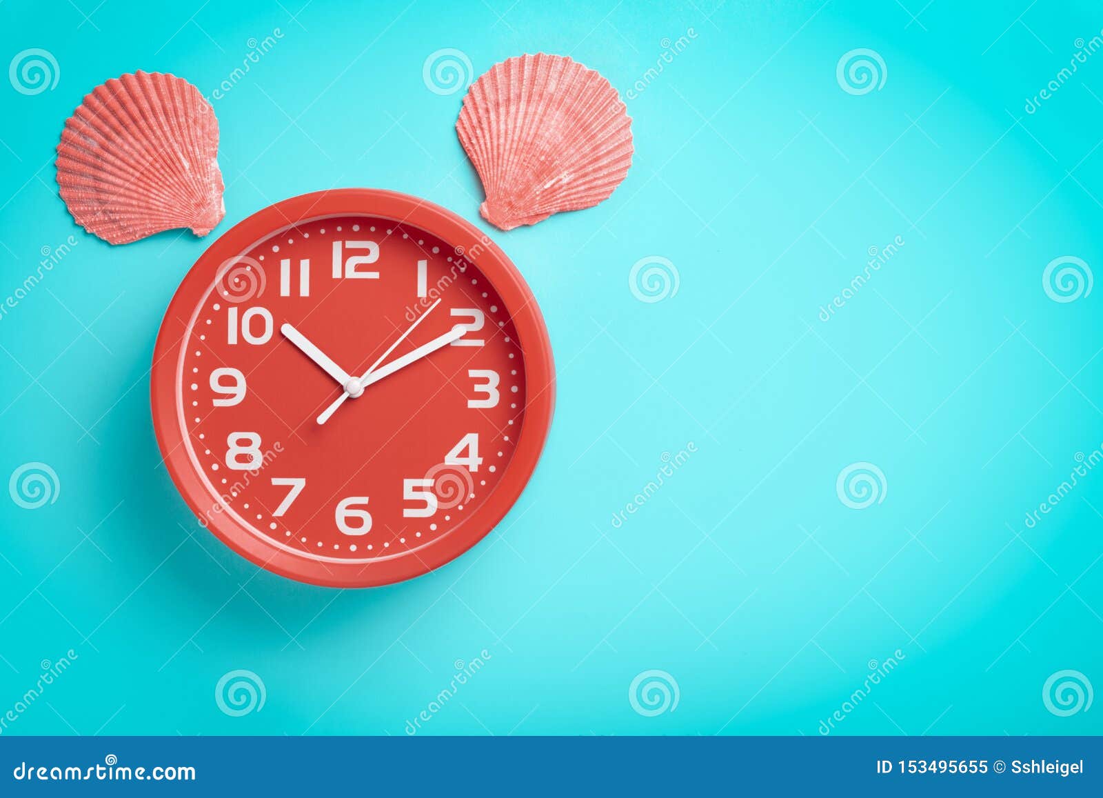 Red Clock with Shells Resembling the Head of an Animal on a Green ...