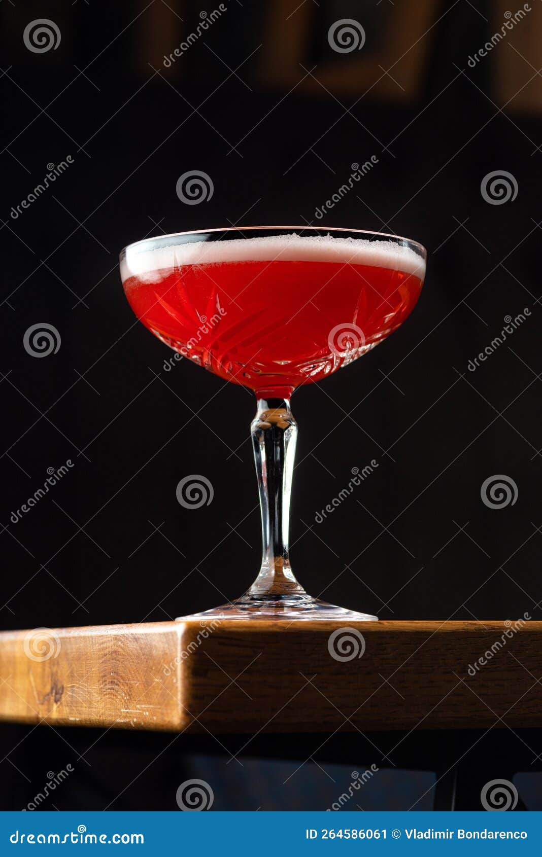 Red Cocktail in Coupe Glass with Layer of Foam on Black Background ...
