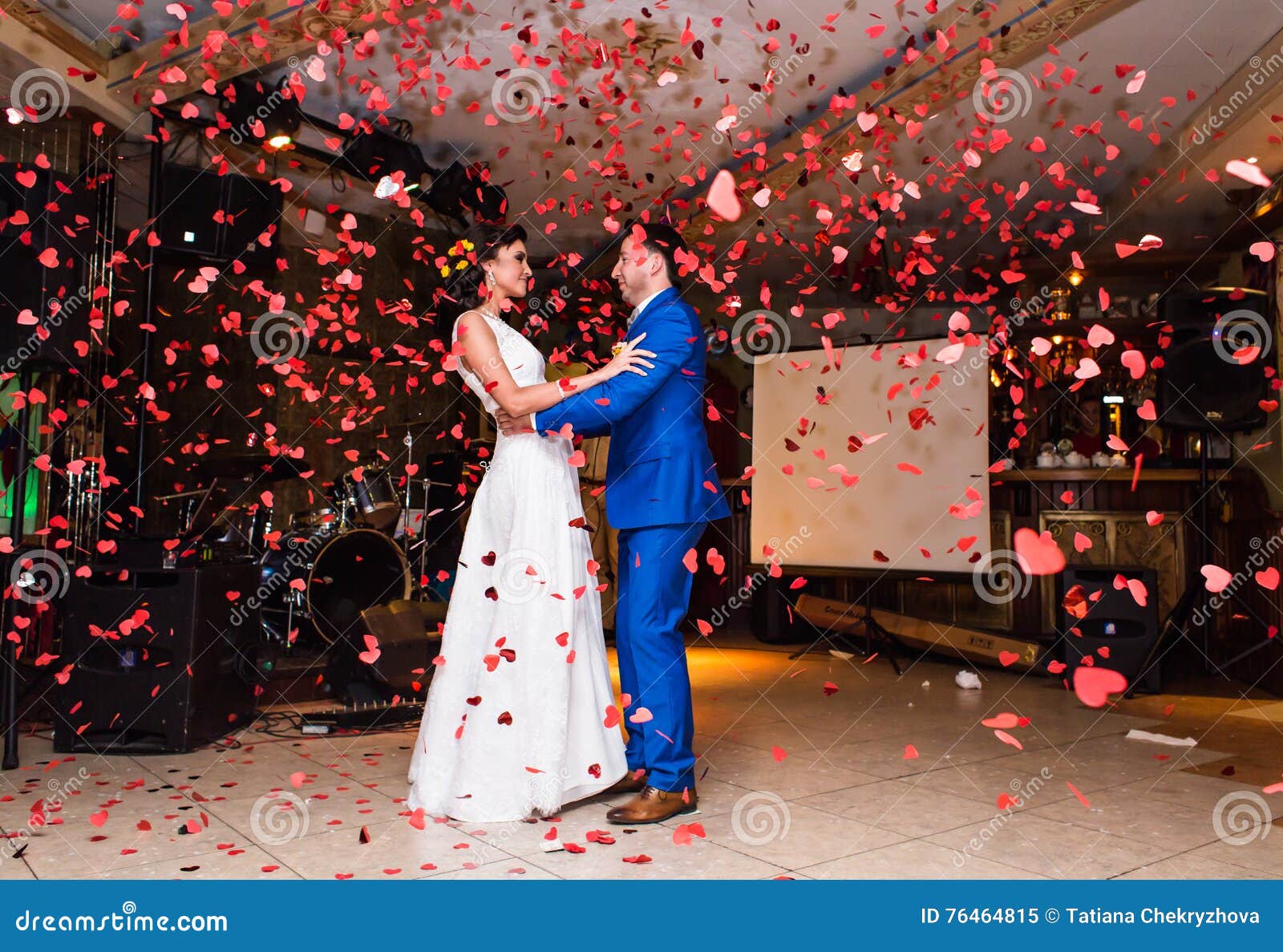Red Confetti Falls Around Dancing Wedding Couple Stock Image - Image of ...