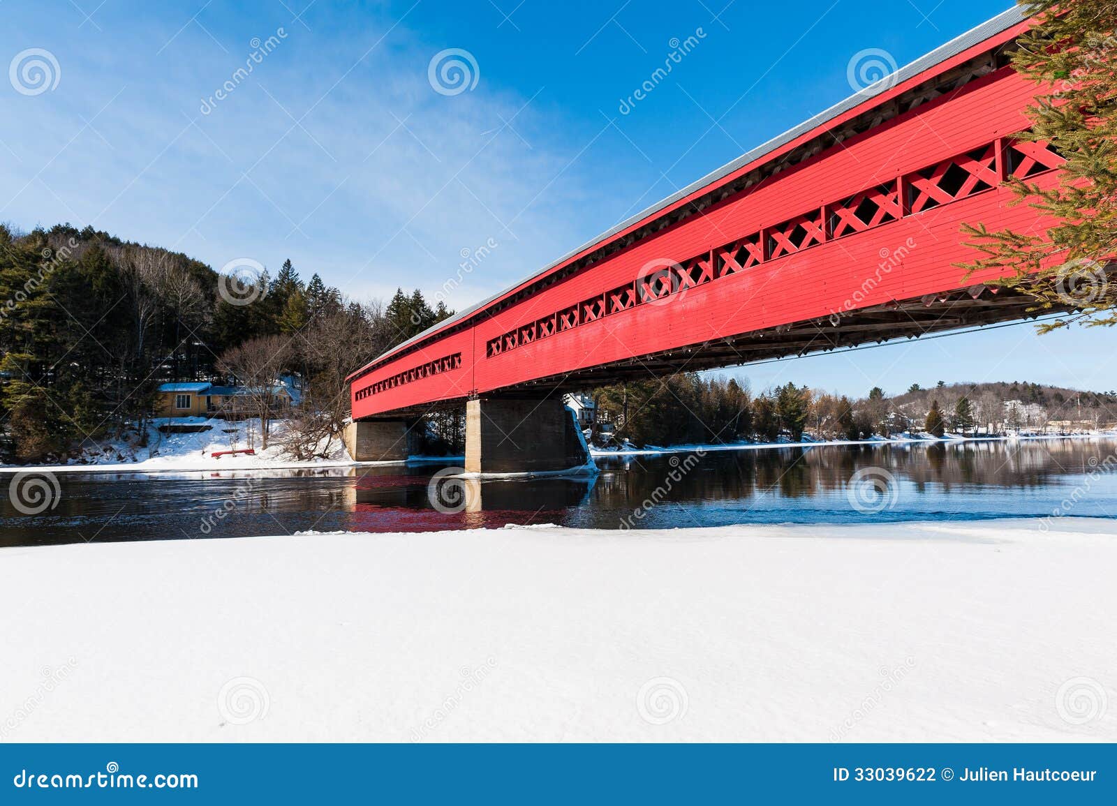 The Red Covered Bridge on the Frozen River Stock Photo - Image of ...