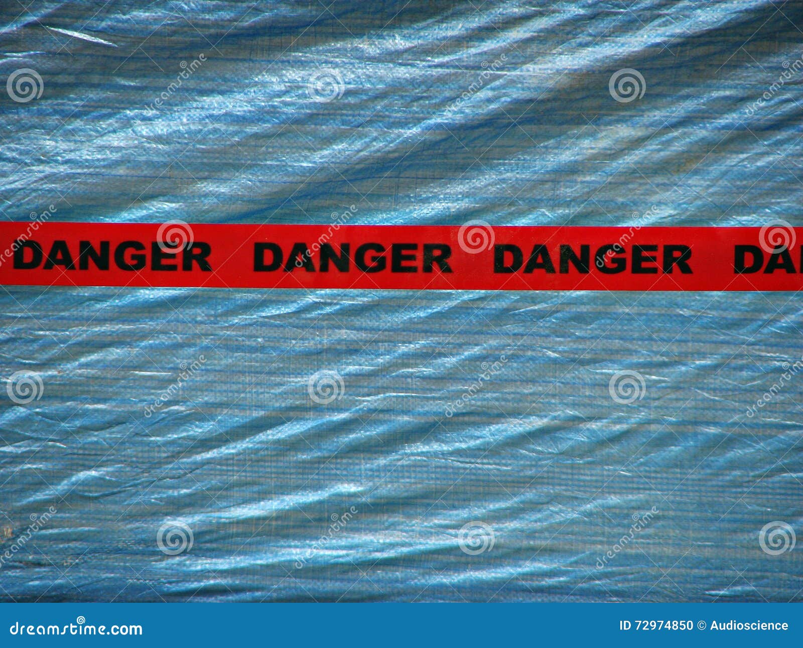 Red Danger Tape Over a Blue Wall Background Stock Photo - Image of line ...