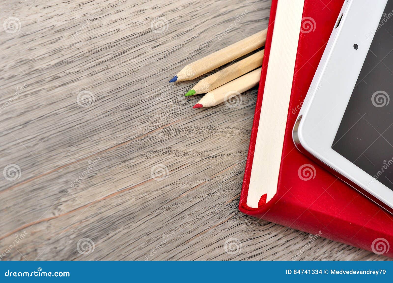 Red Diary Notebook, White Tablet and Colored Pencils on Desk Woo Stock ...