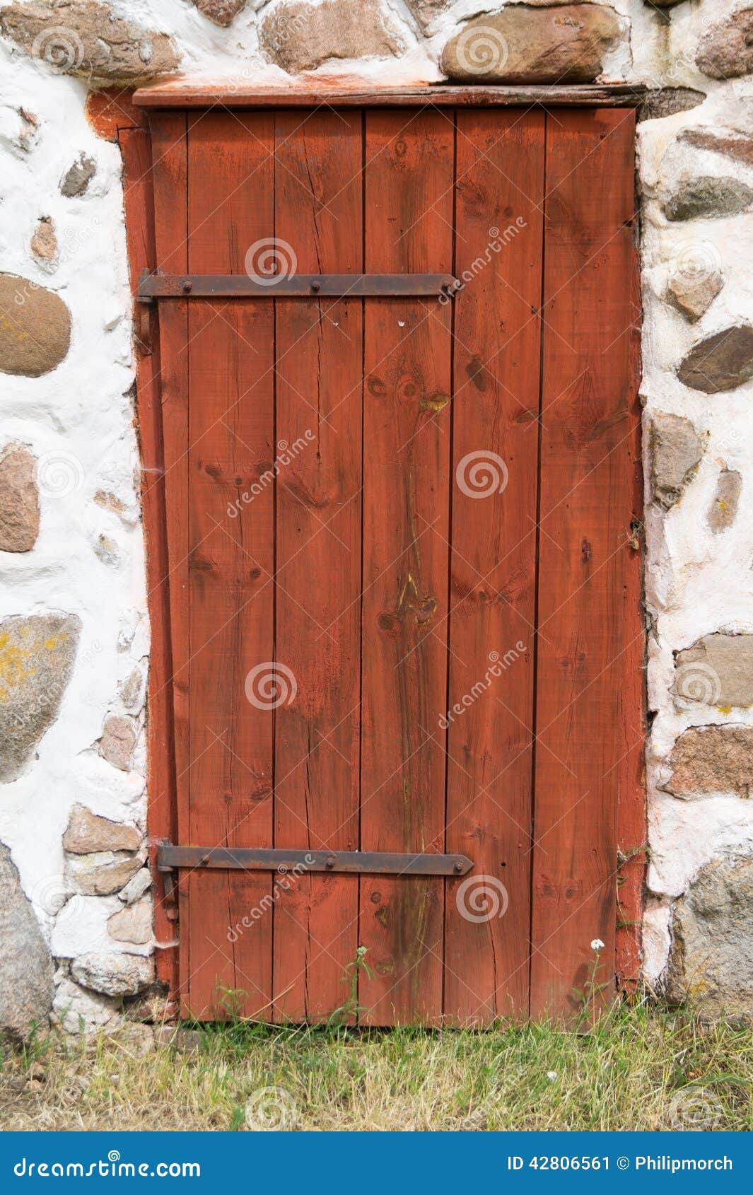 Red Wooden Door in Stone Boulder Wall Stock Image - Image of door ...