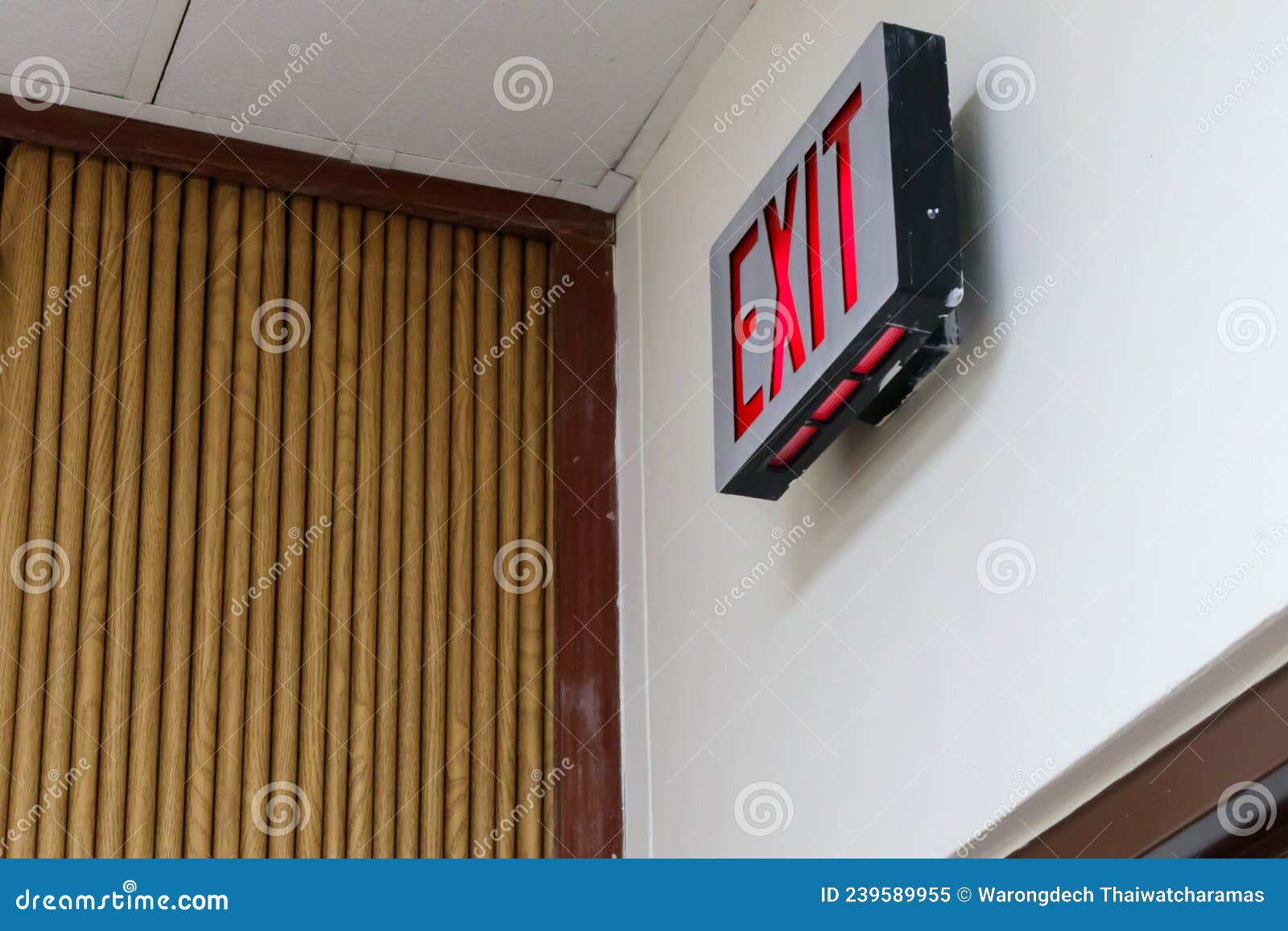 Red Emergency Exit Sign in the Dark Room. Illuminated Office Exit Sign ...