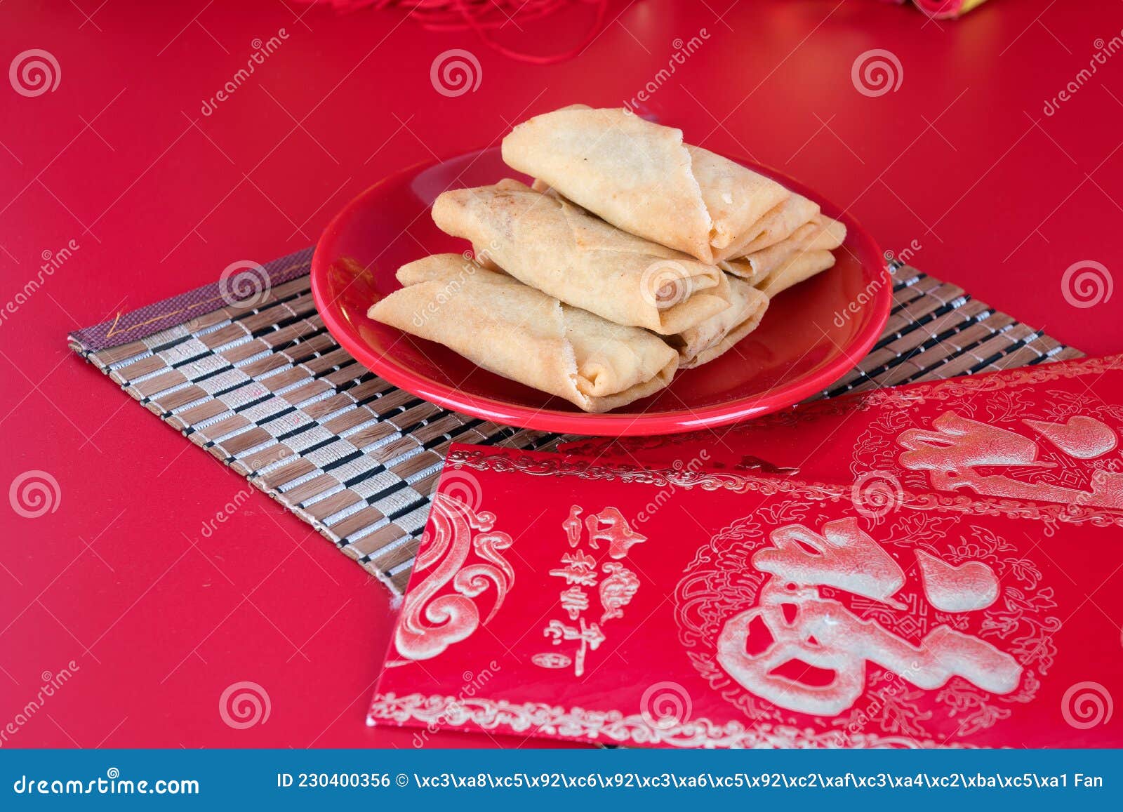 Red Envelopes on a Red Background and a Plate of Fried Spring Rolls ...