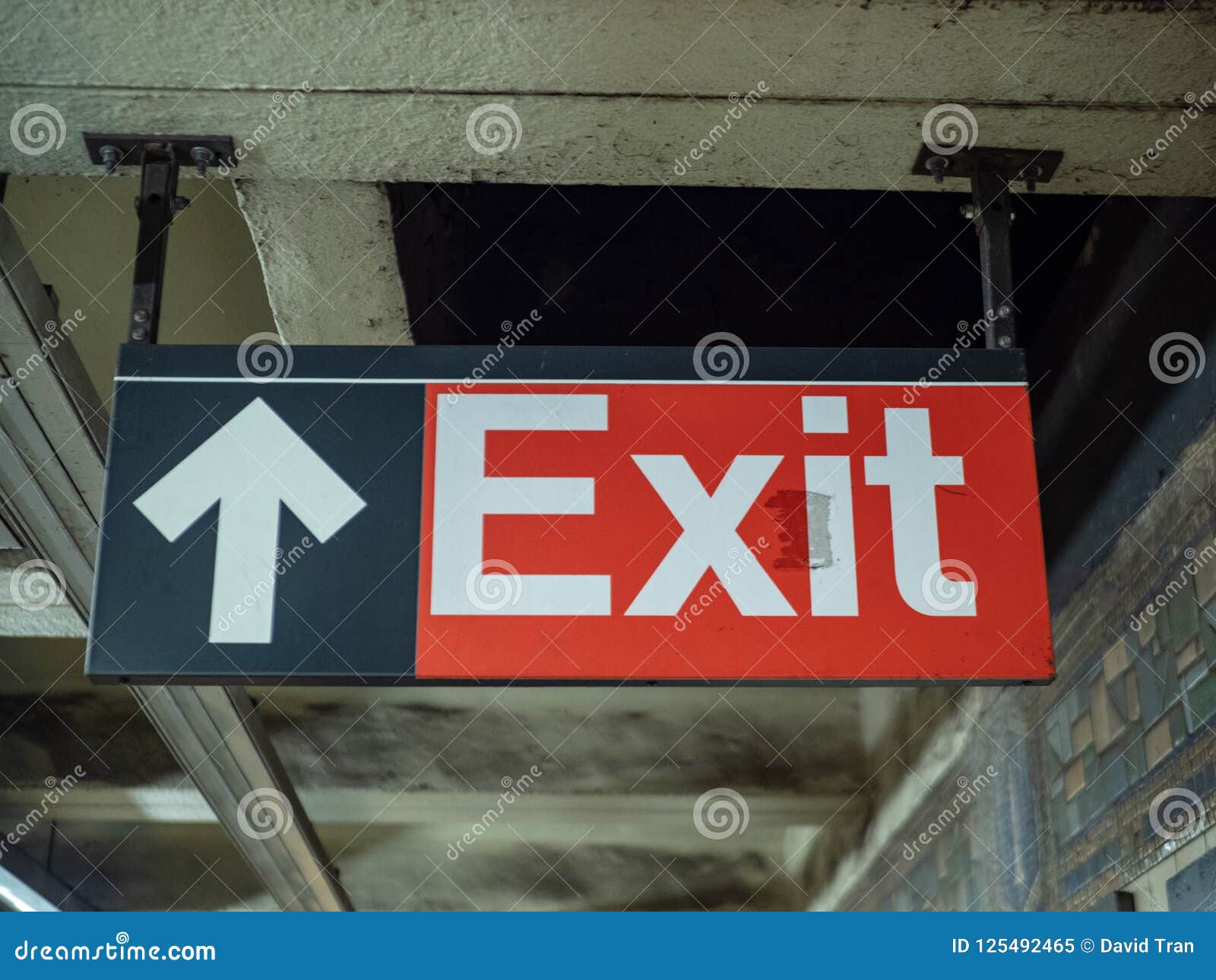 Red Exit Sign with Arrow Hanging in Underground Subway Station Stock ...