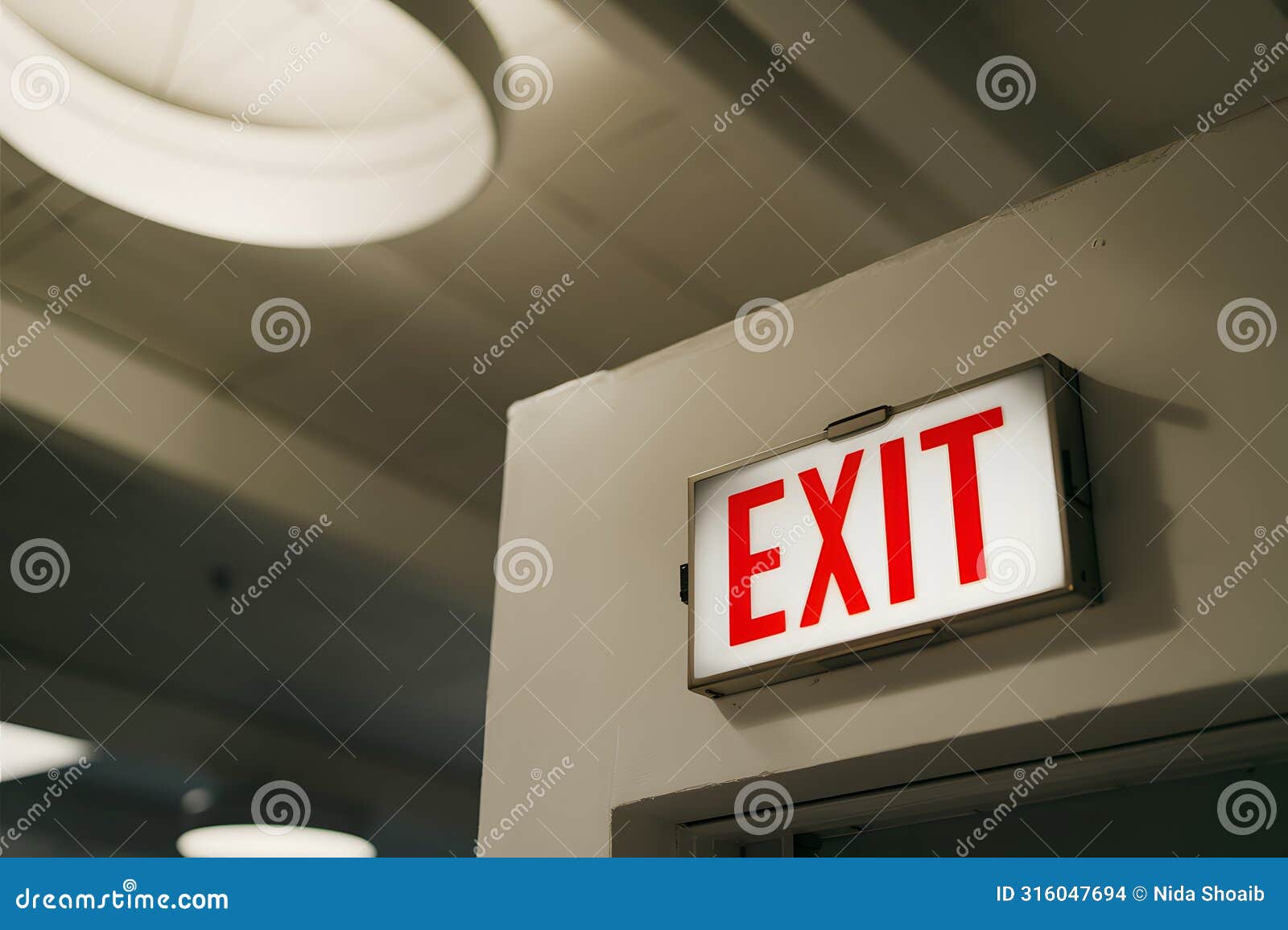 Red EXIT Sign with White Background, Ceiling Light Fixture, and ...