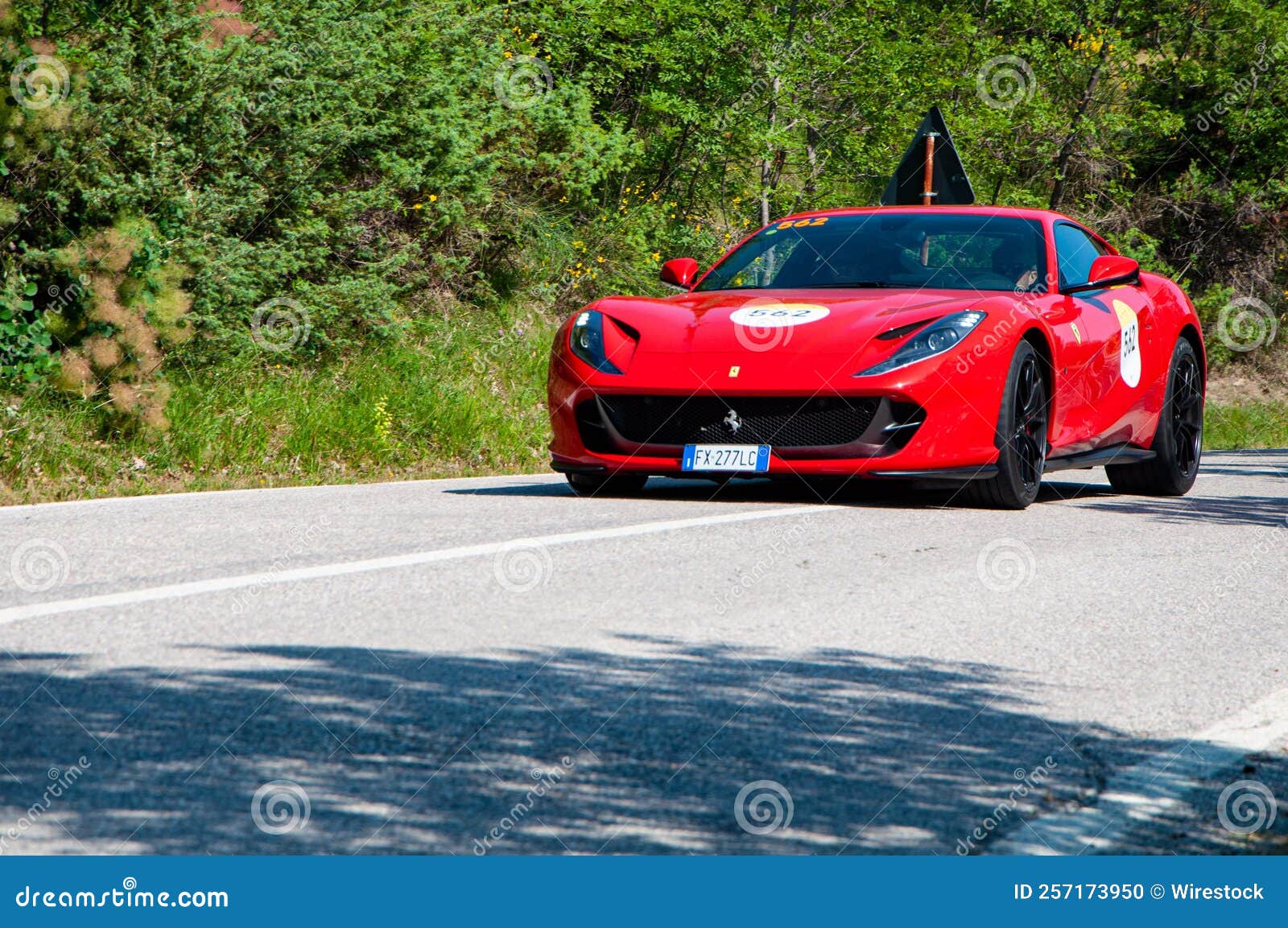 Red Ferrari 812 Superfast during the Mille Miglia 2022 with Trees in ...