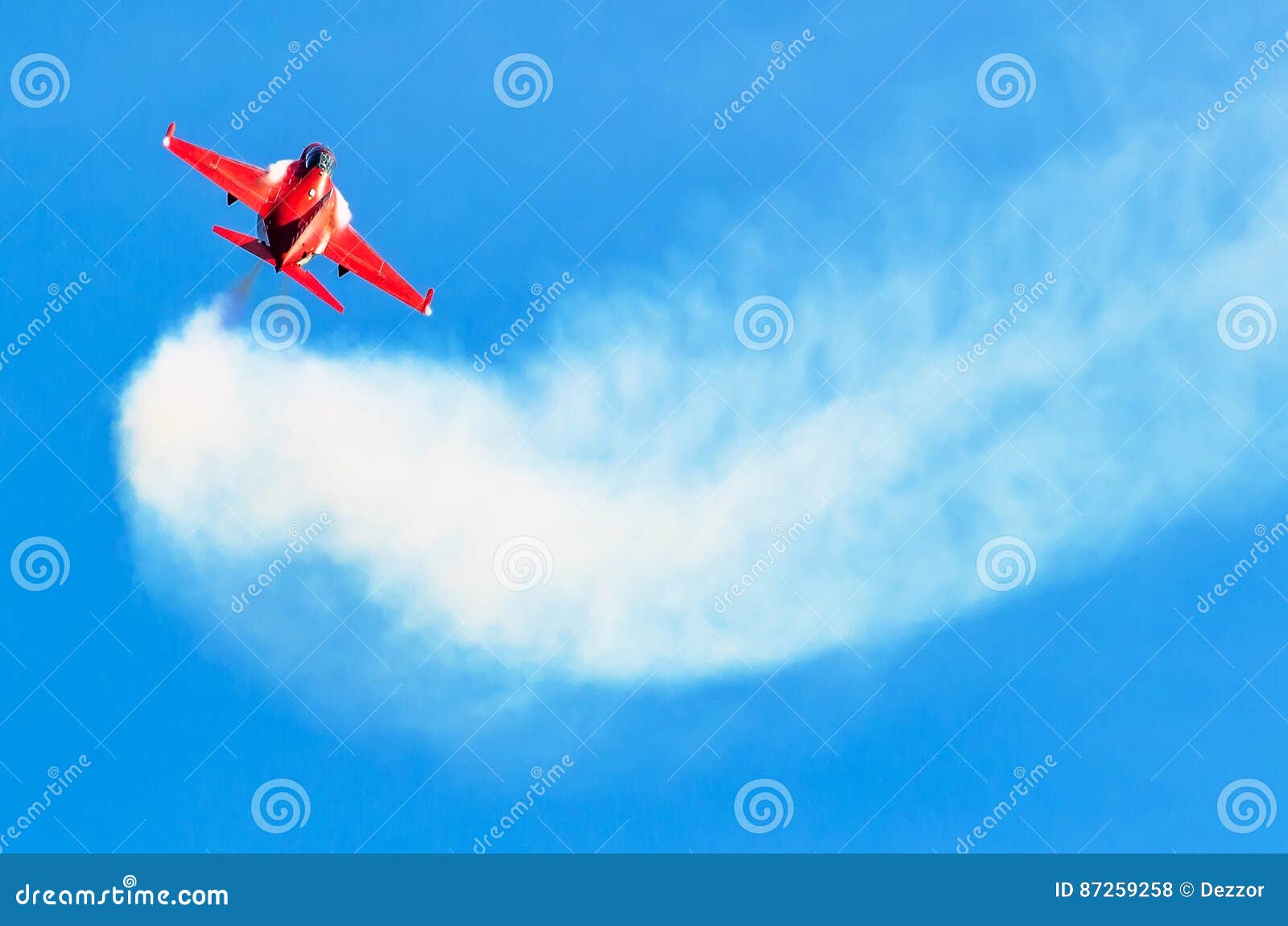 Red Fighter Jet in the Blue Sky with White Smoke Trail Stock Photo ...