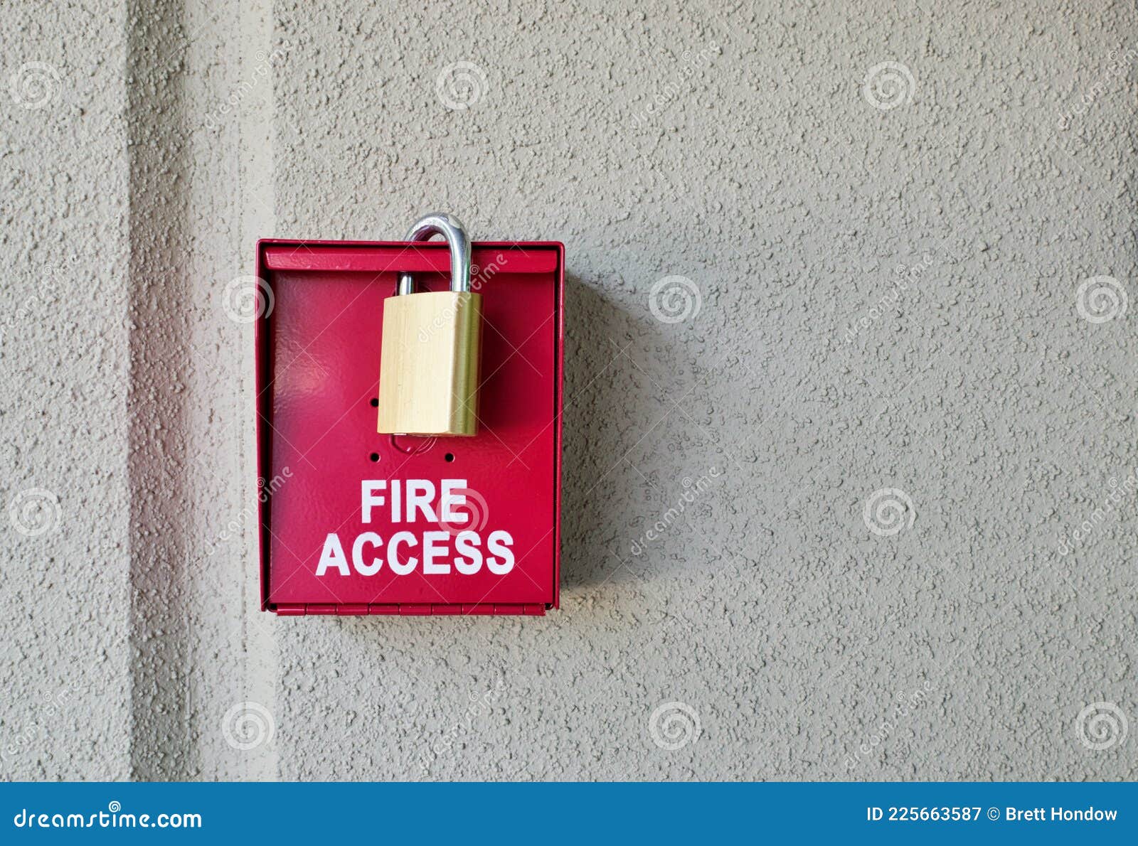 Red Fire Access Box with Padlock on a Plain Textured Wall. Stock Image ...