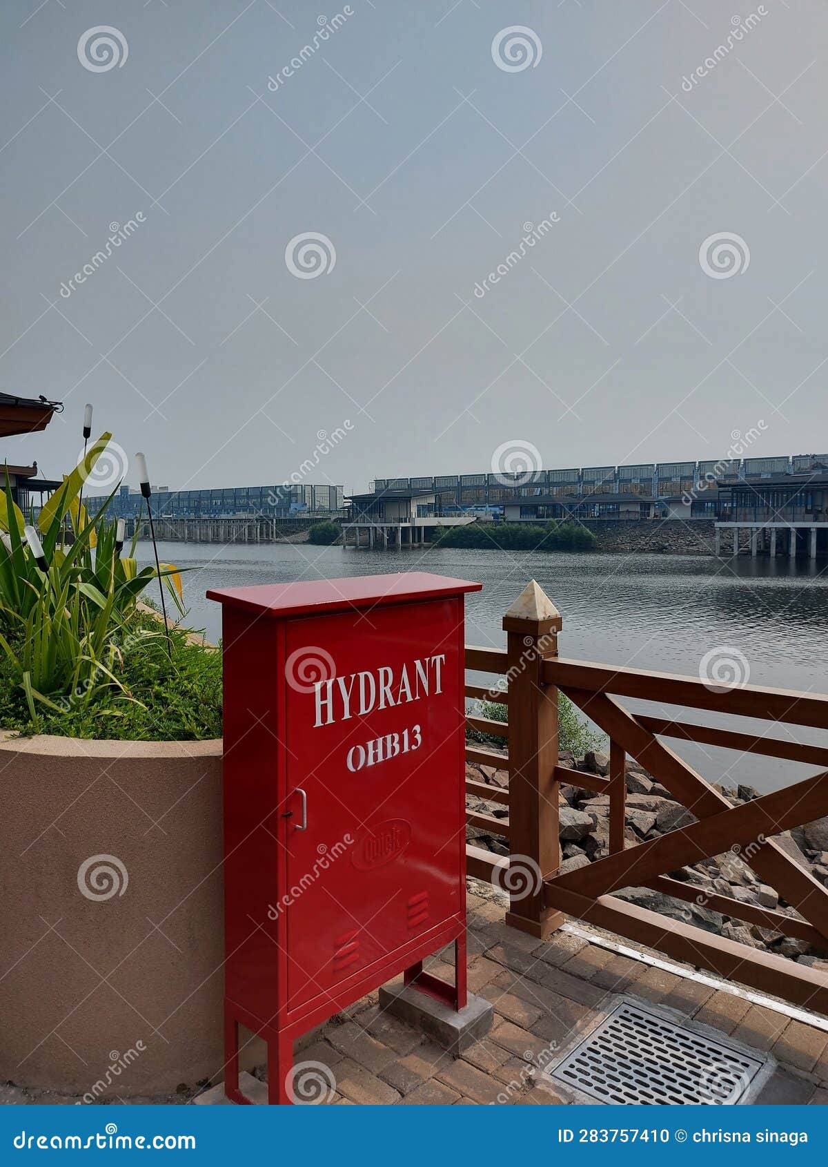 A Red Fire Extinguisher on the Edge of the Wharf Stock Photo - Image of ...