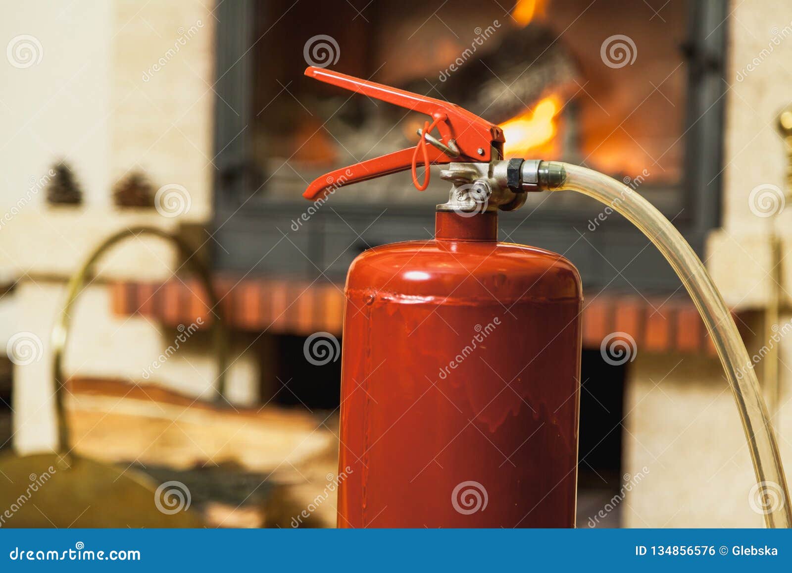 Fire and Safety. Fire Extinguisher Stands in Front of Fireplace Stock ...