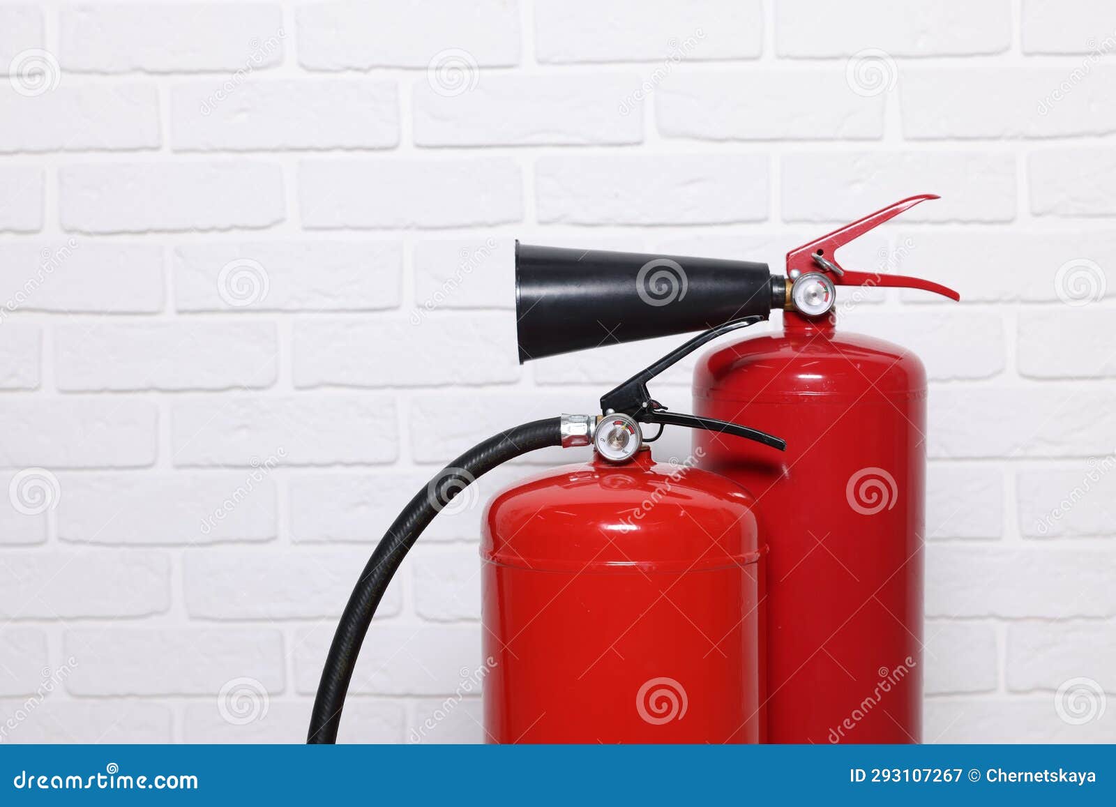 Red Fire Extinguishers Near White Brick Wall, Space for Text Stock ...