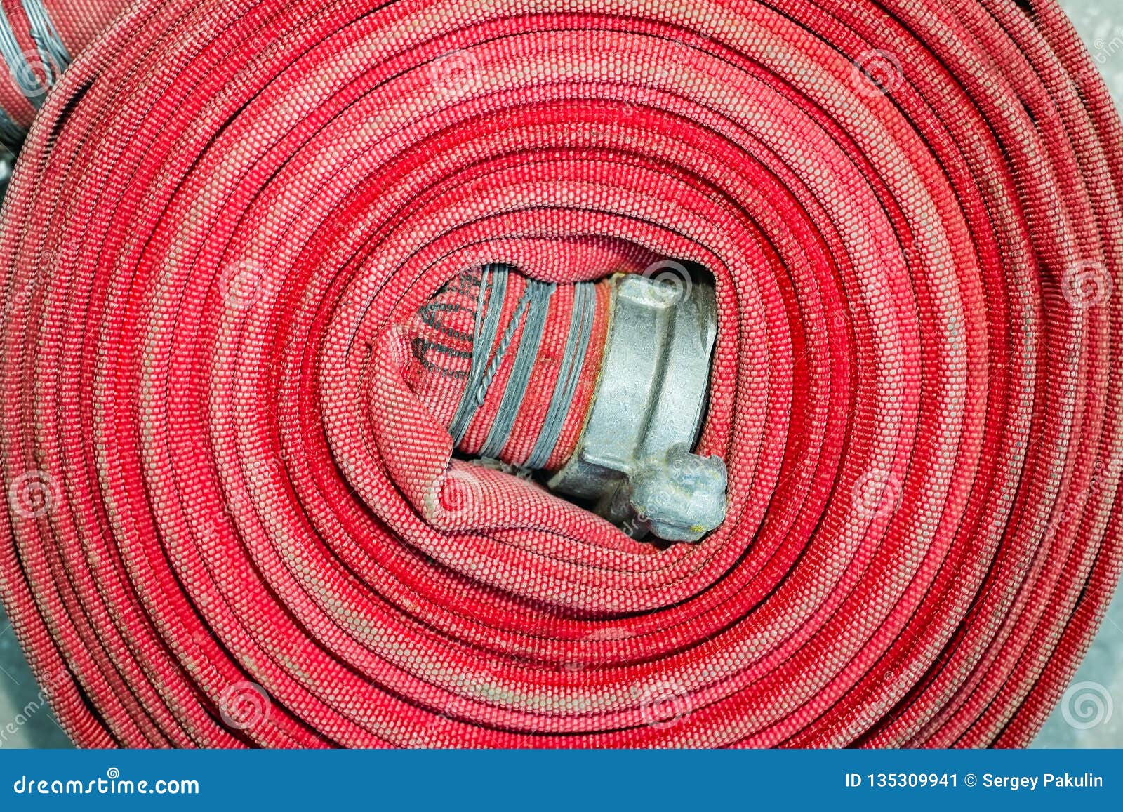 Red Fire Hose is Wound into a Spiral. Close-up. View from Above Stock ...