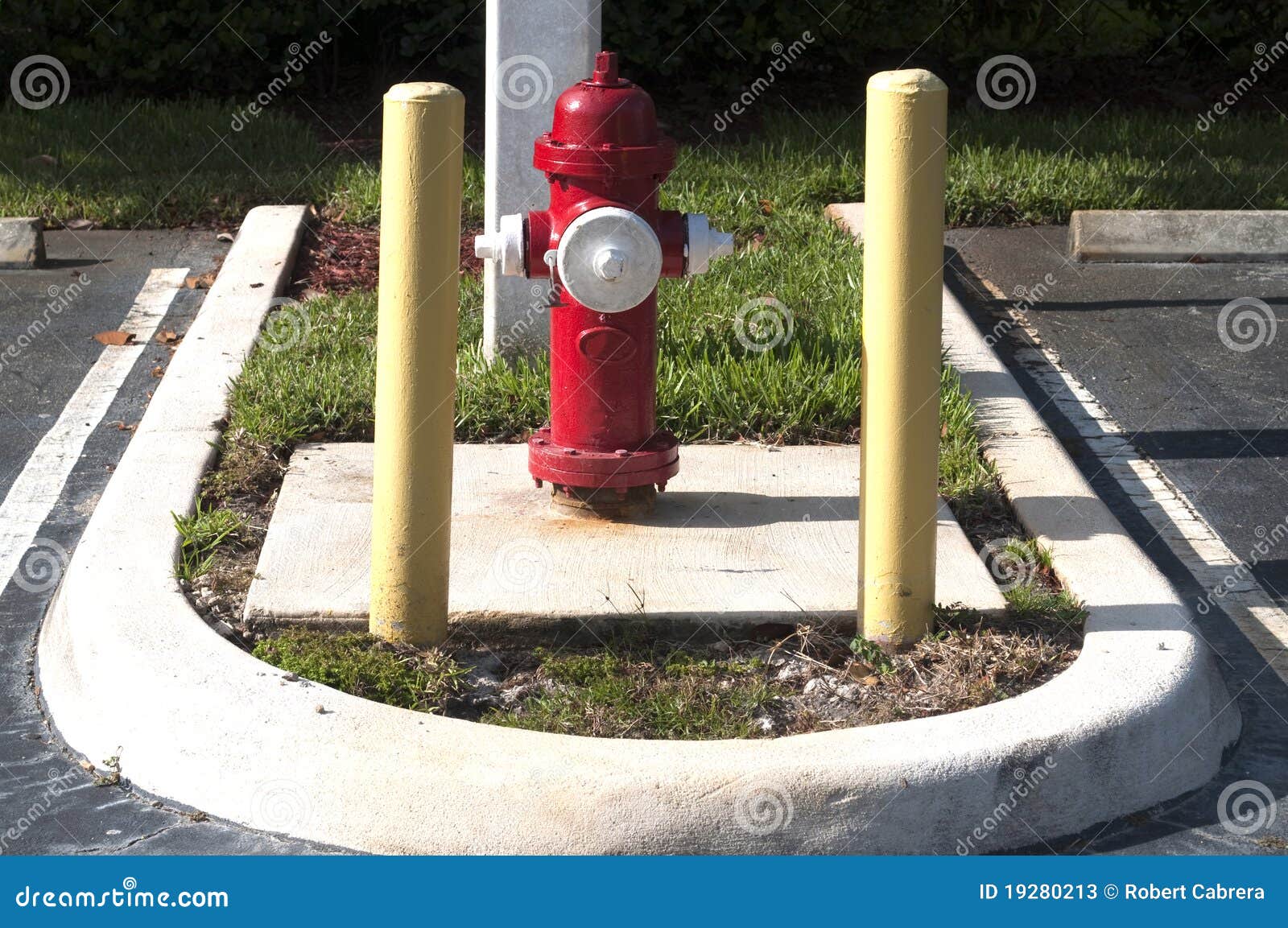 Red Fire Hydrant in Parking Lot with Safety Poles Stock Image - Image ...