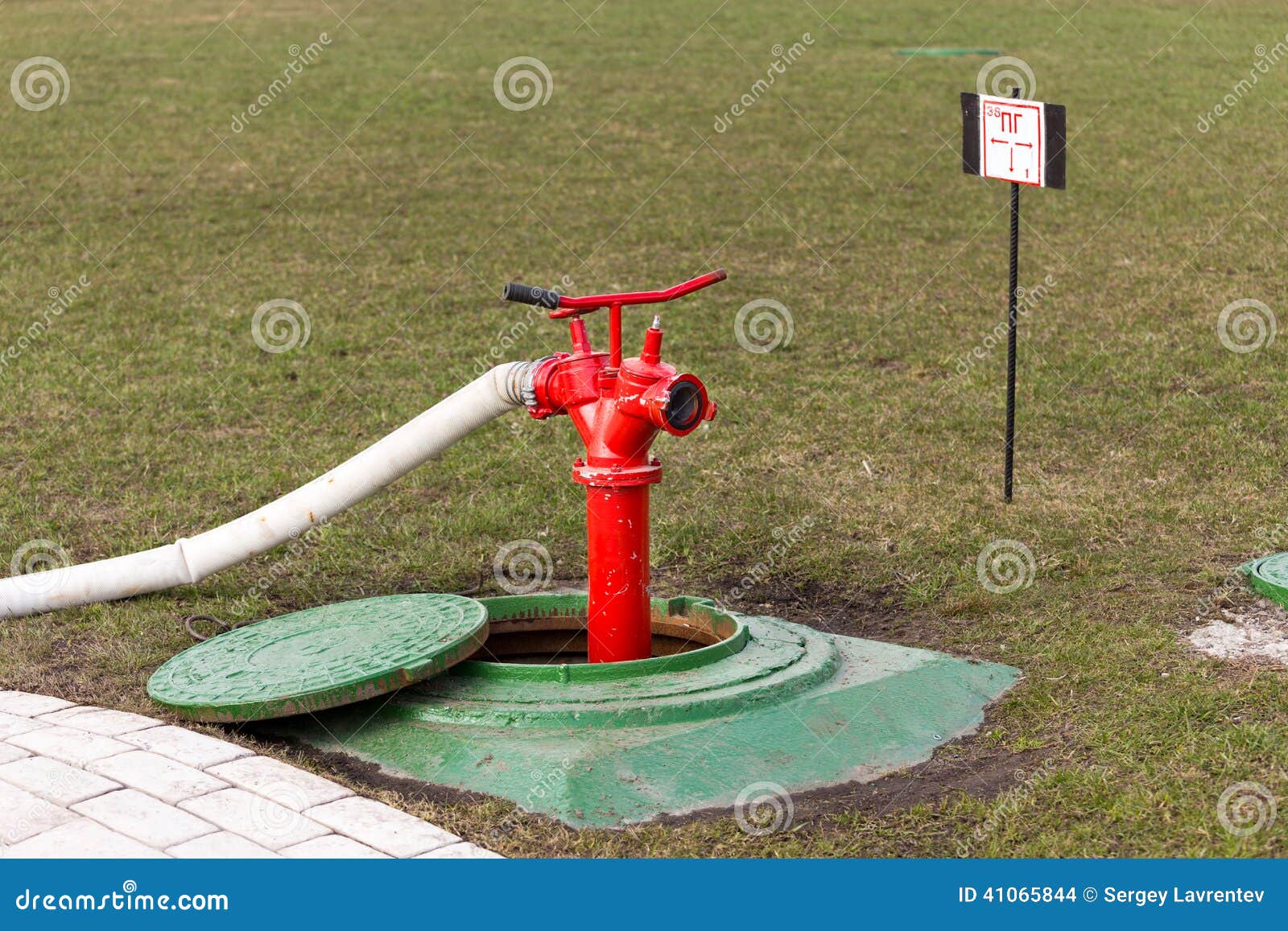 Red Fire Hydrant Stands in Manhole Stock Photo - Image of water ...
