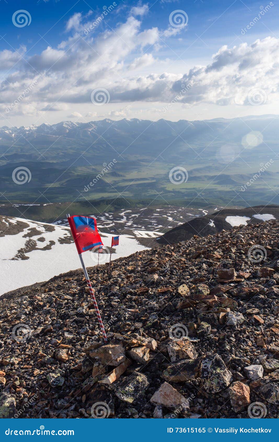 Red Flag Flying in the Background of the Mountains Stock Image - Image ...