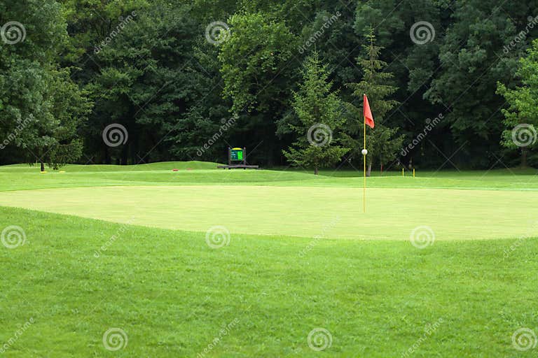 Red flag on a golf course stock image. Image of background - 56747459
