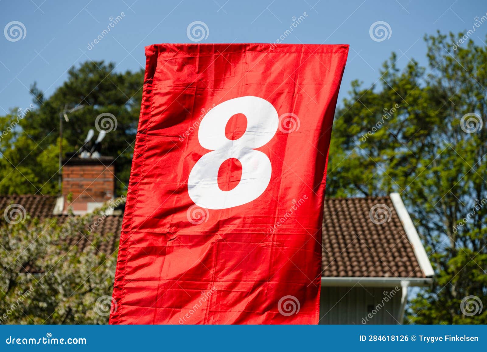 Red Flag Marked 8 Waving in the Wind.. Stock Photo - Image of blue ...