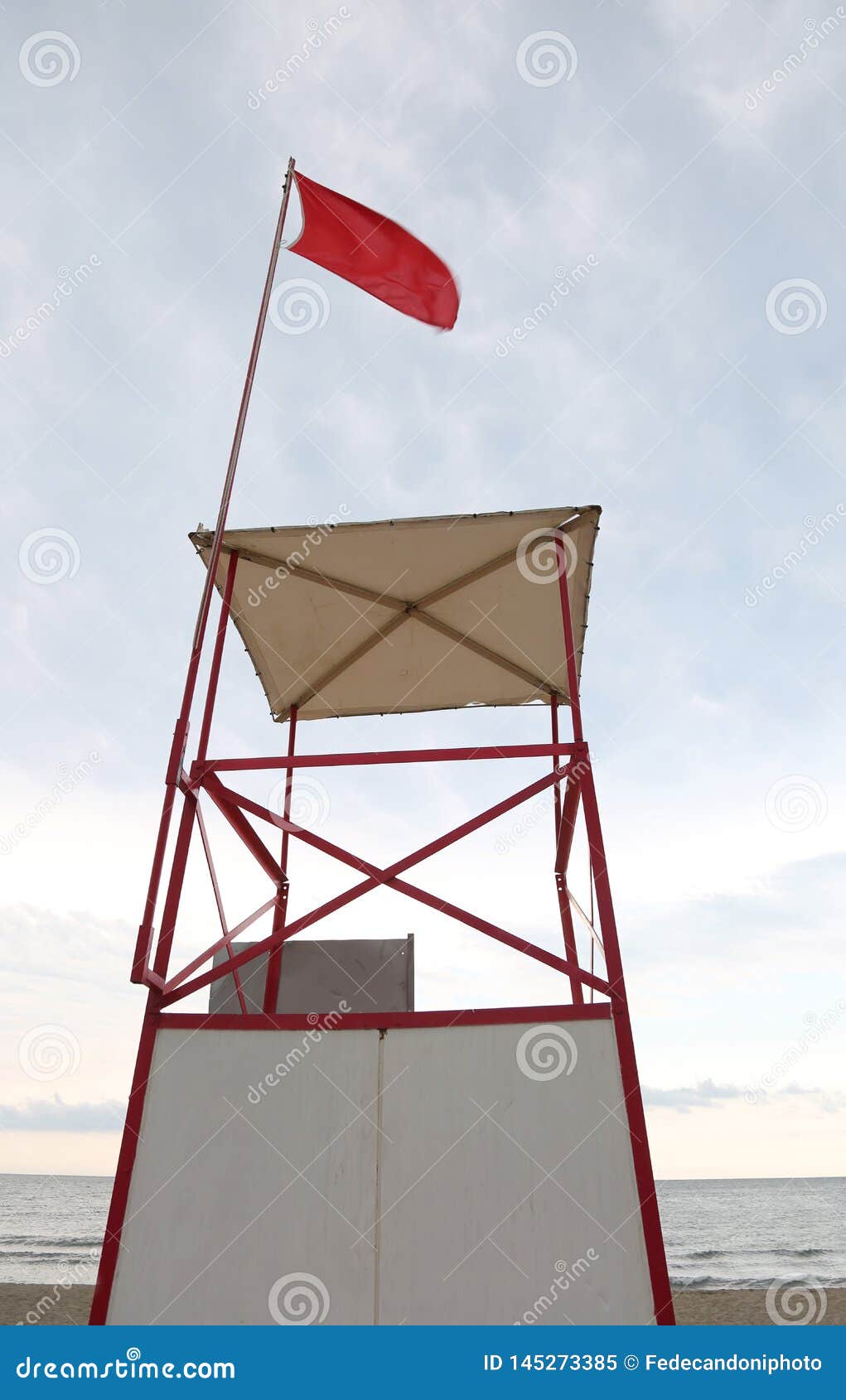 Red Flag Symbol of Danger in the Turret on the Beach Stock Image ...