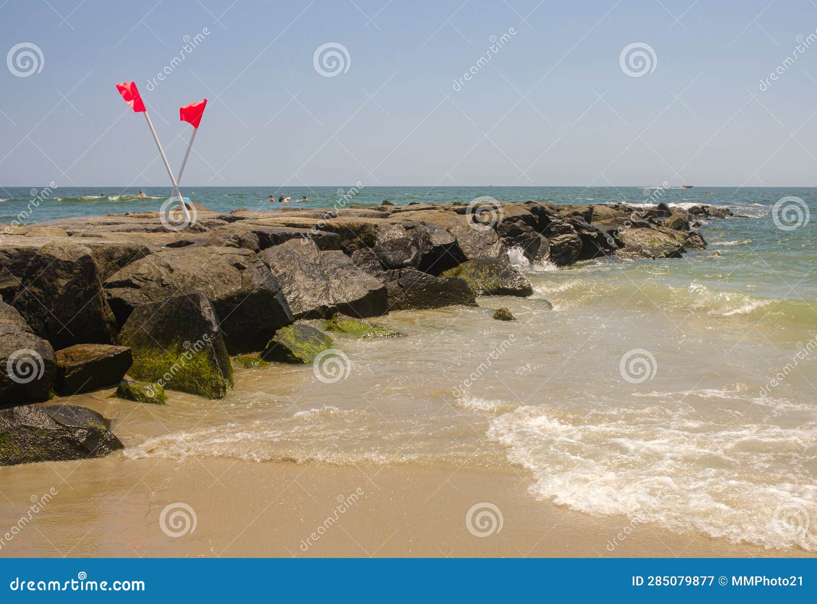 Red Flags on Ocean Rock Jetty, Safety Amidst the Waves Stock Image ...