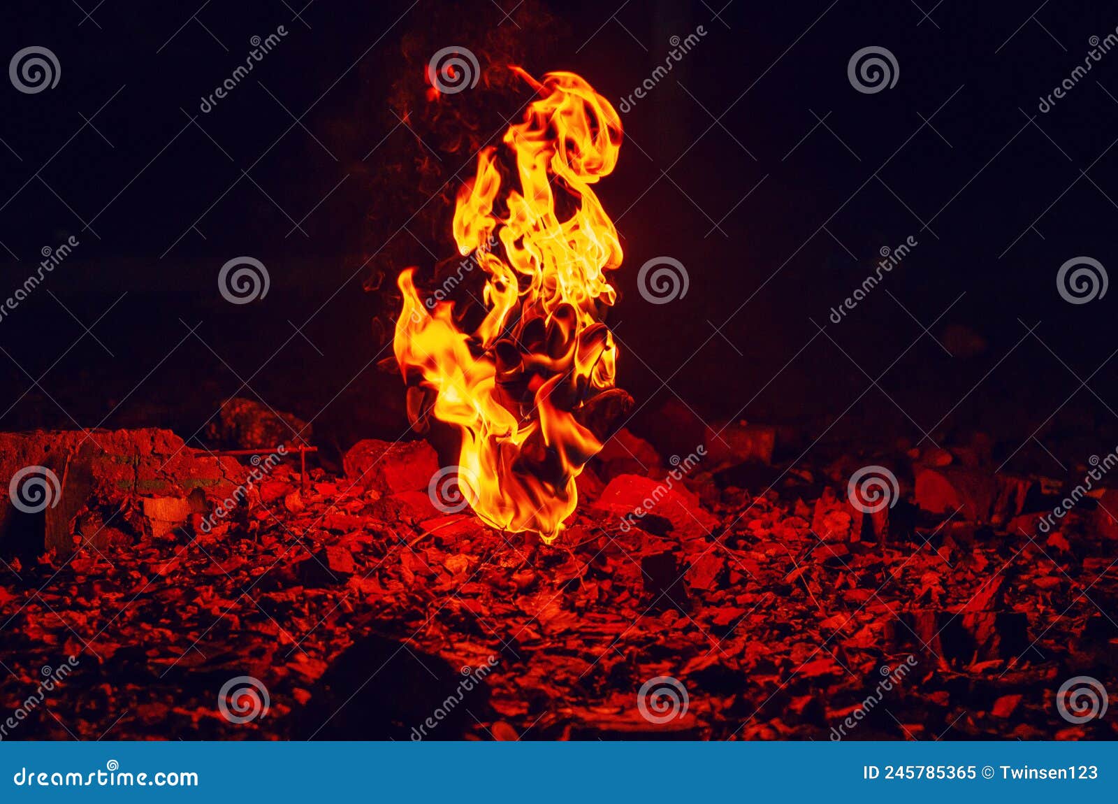 Red Flame of a Burning Fire Rising from a Stone Covered with Autumn ...