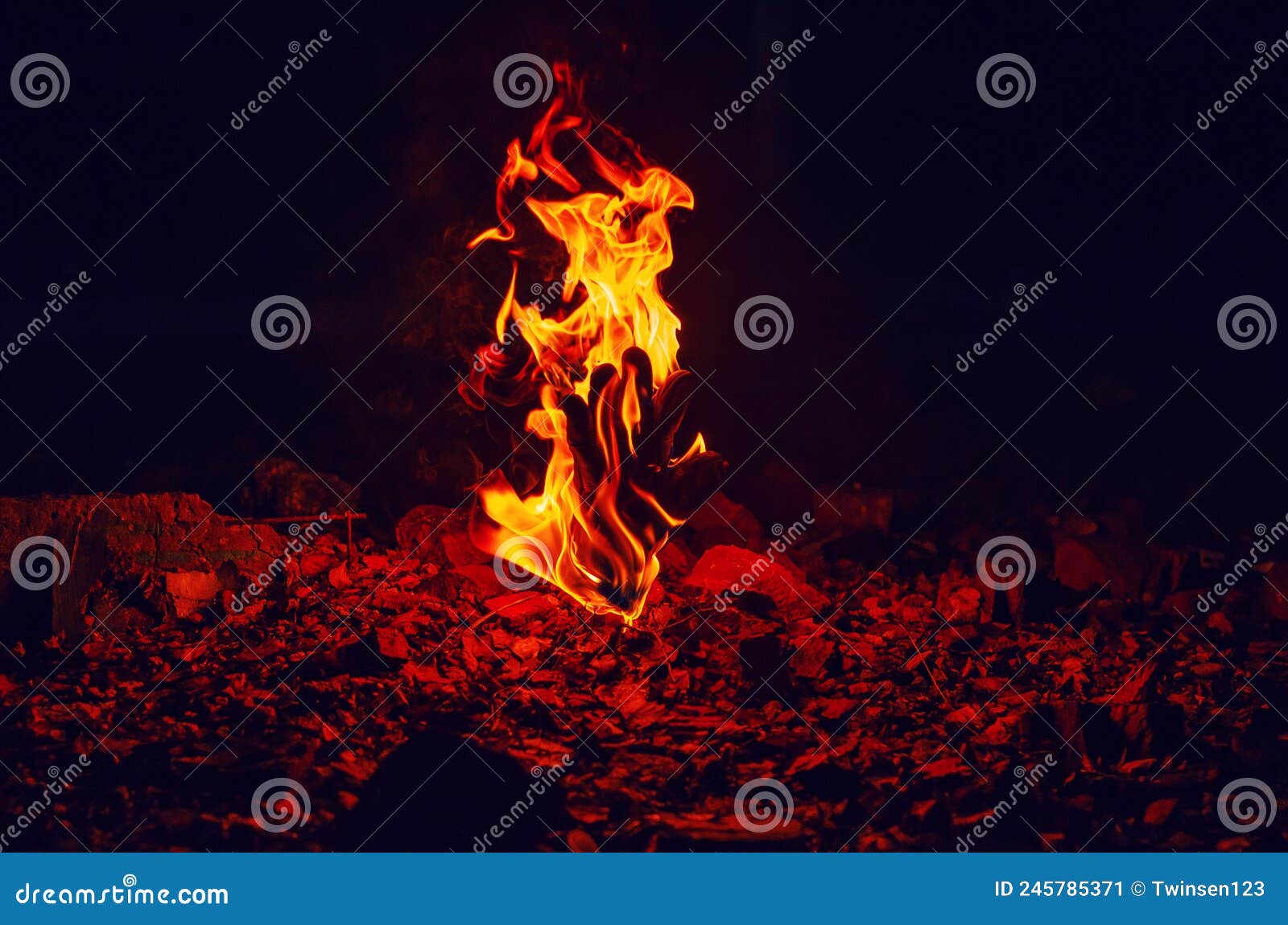 Red Flame of a Burning Fire Rising from a Stone Covered with Autumn ...