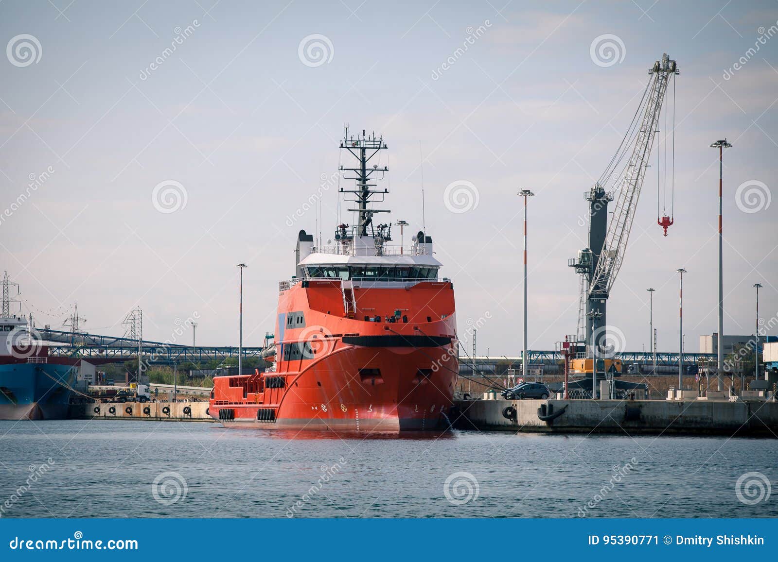 Red Freight Ship in Front of Port Facilities and Cranes Stock Image ...